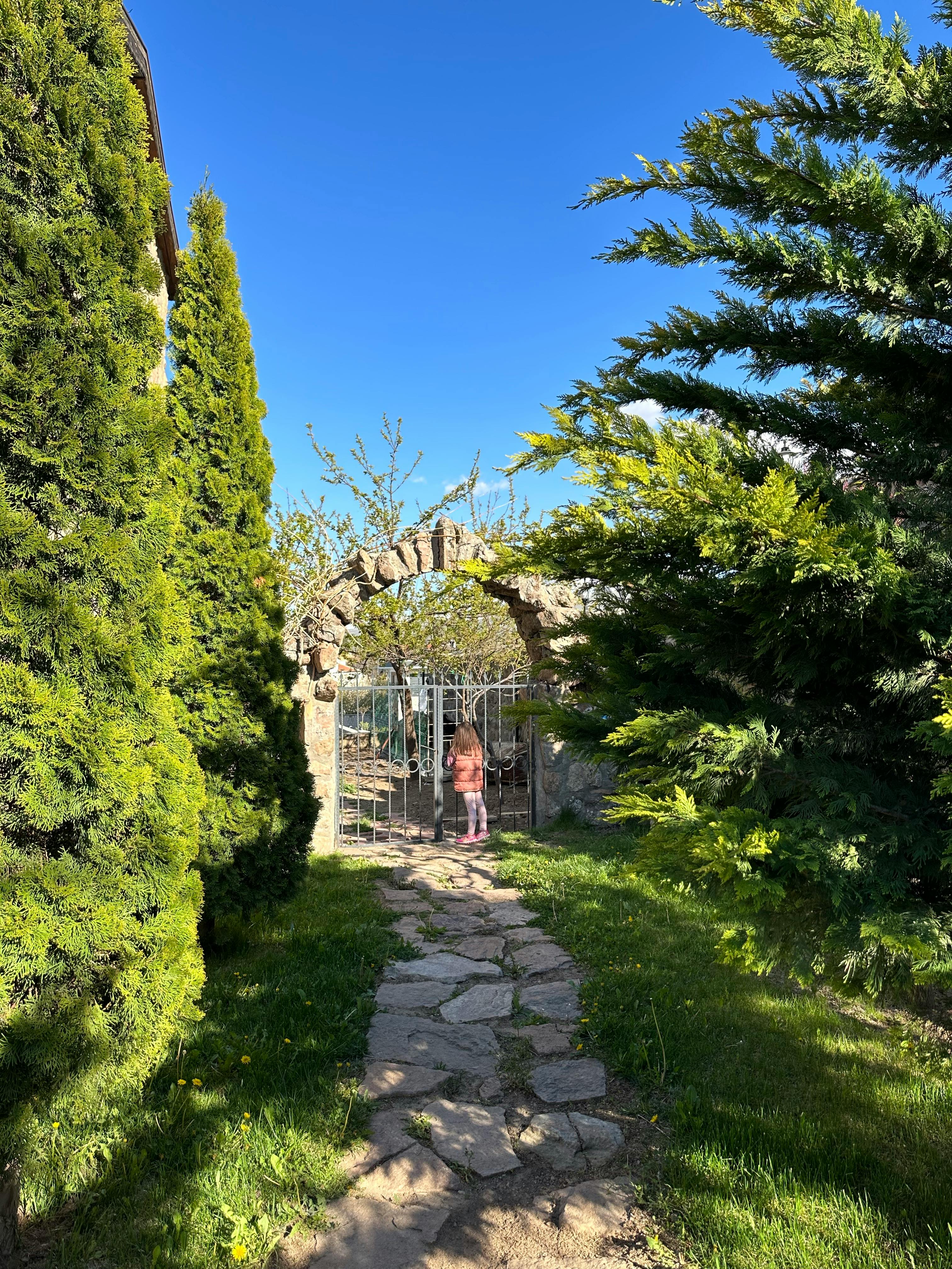 Little Girl Waiting by Gate at End of Footpath Running between Trees ...