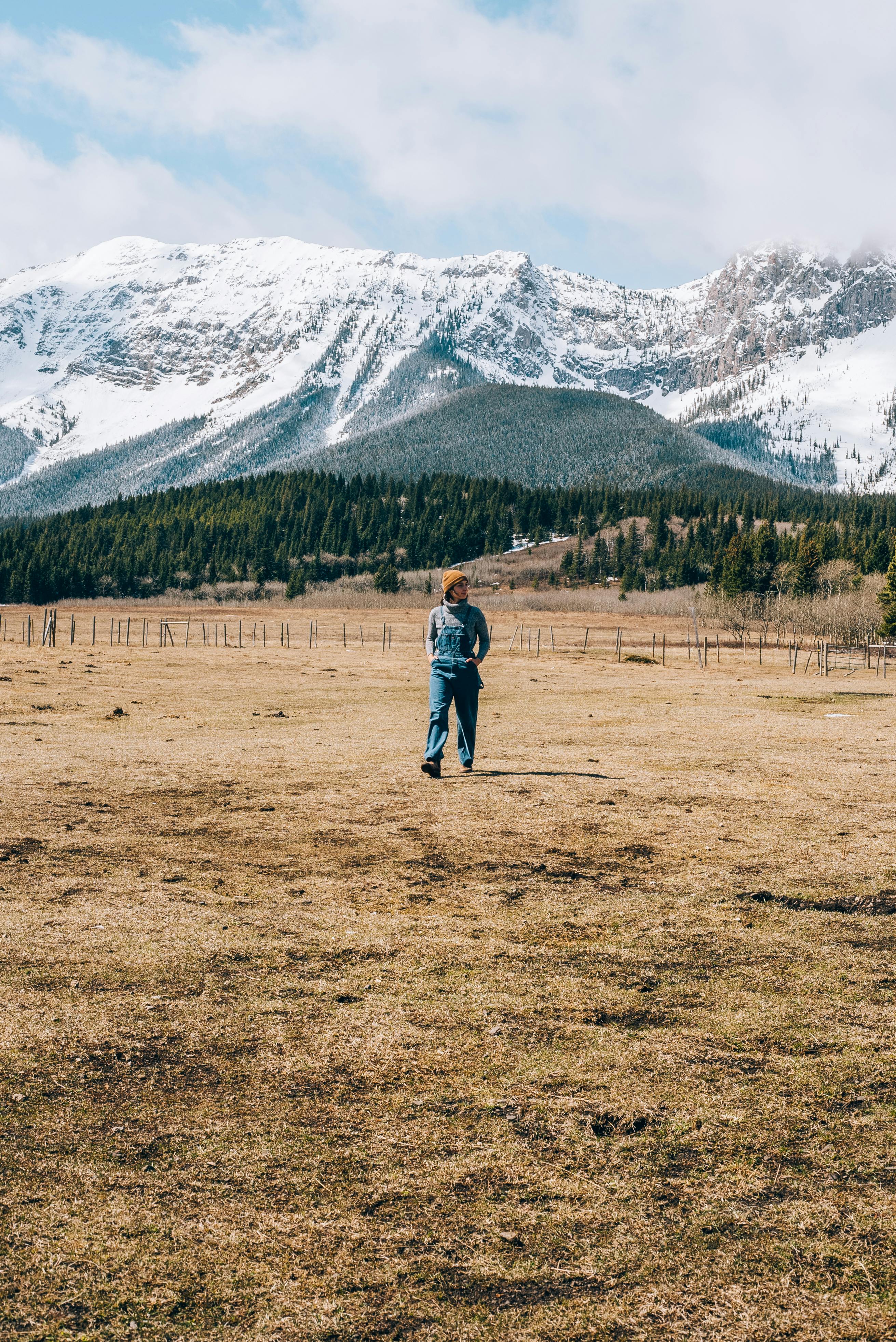 Man Walking in Field in Mountains Landscape · Free Stock Photo
