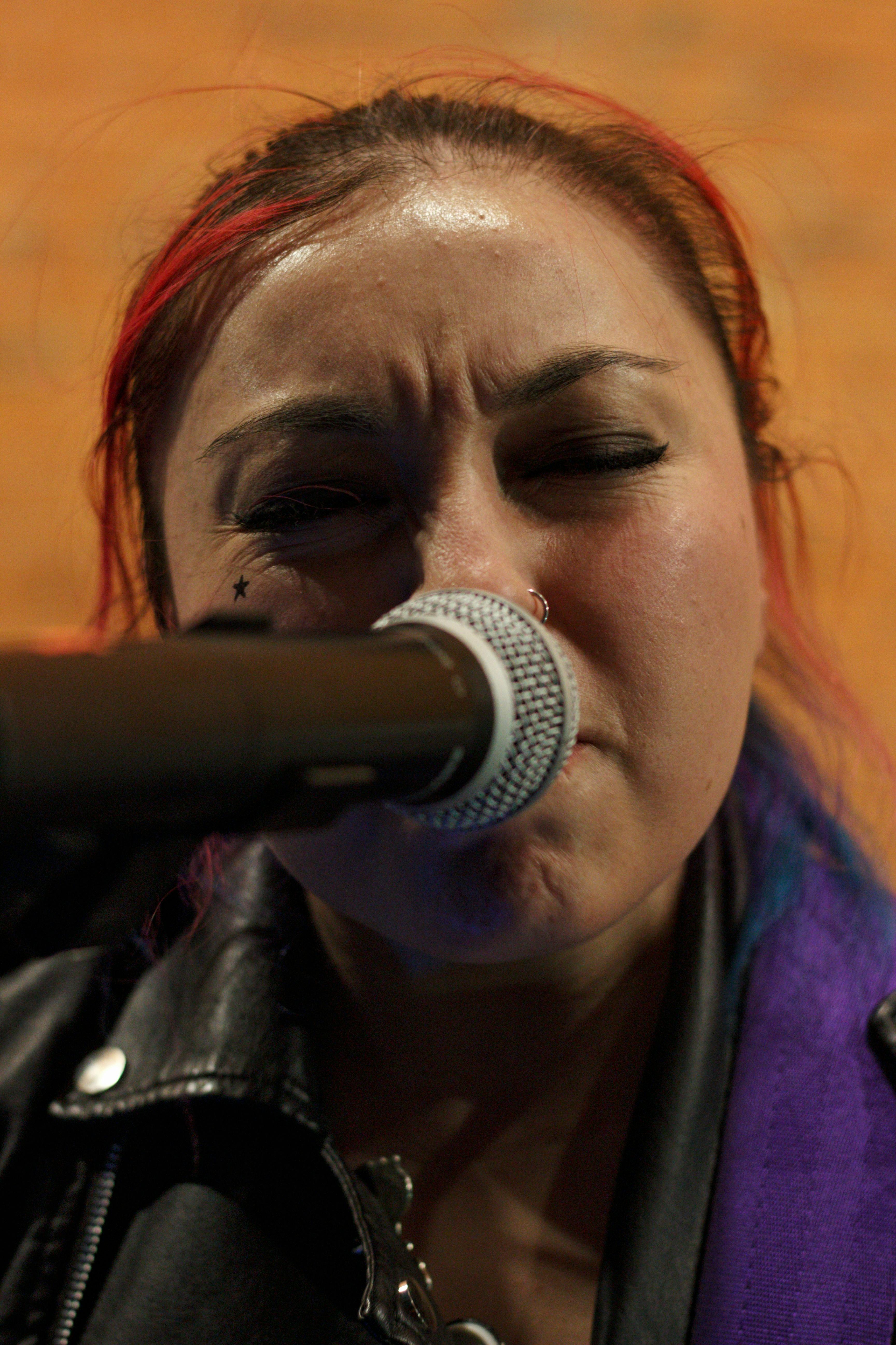 Woman Singing to a Microphone · Free Stock Photo