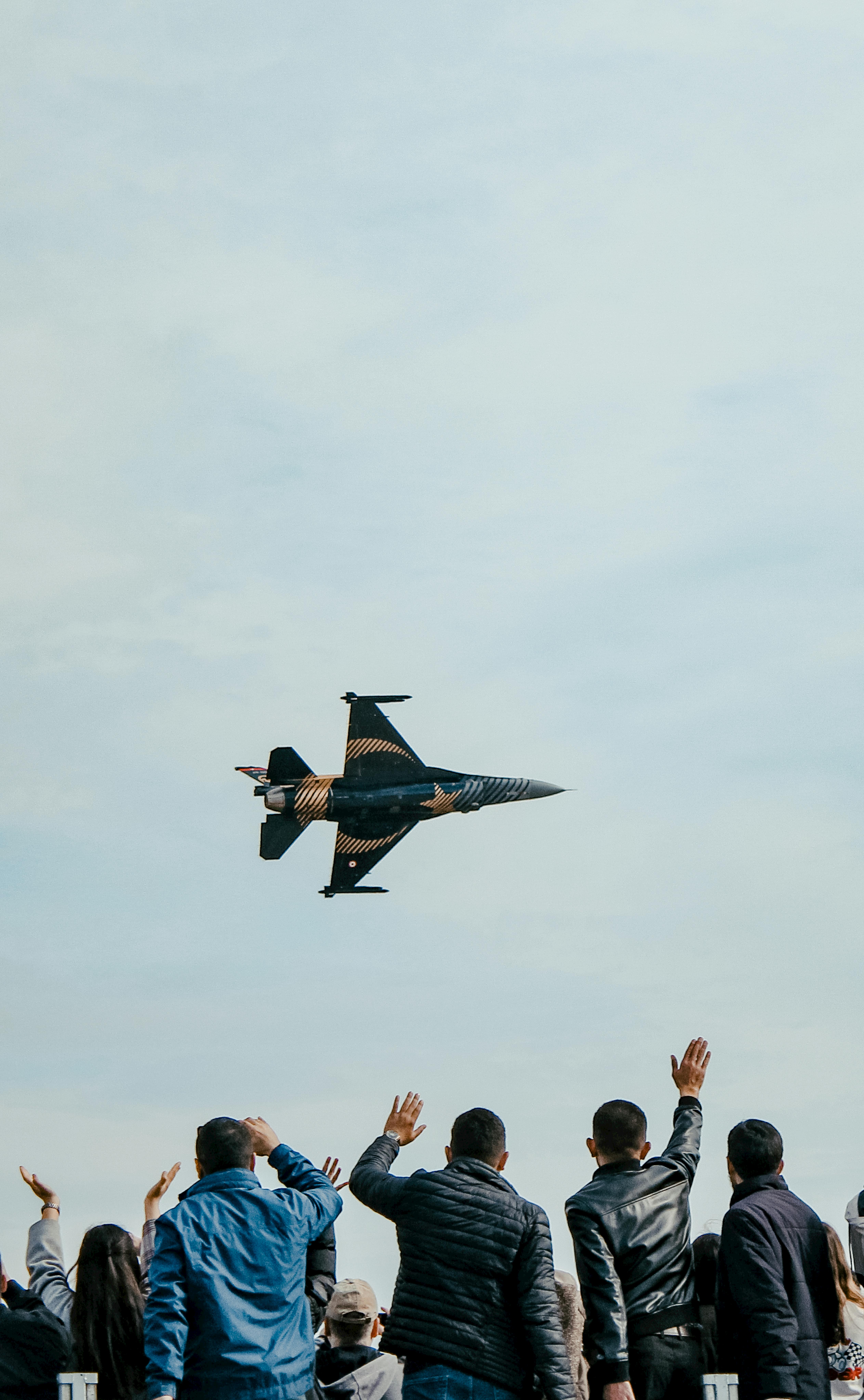 A jet flying over a crowd of people · Free Stock Photo
