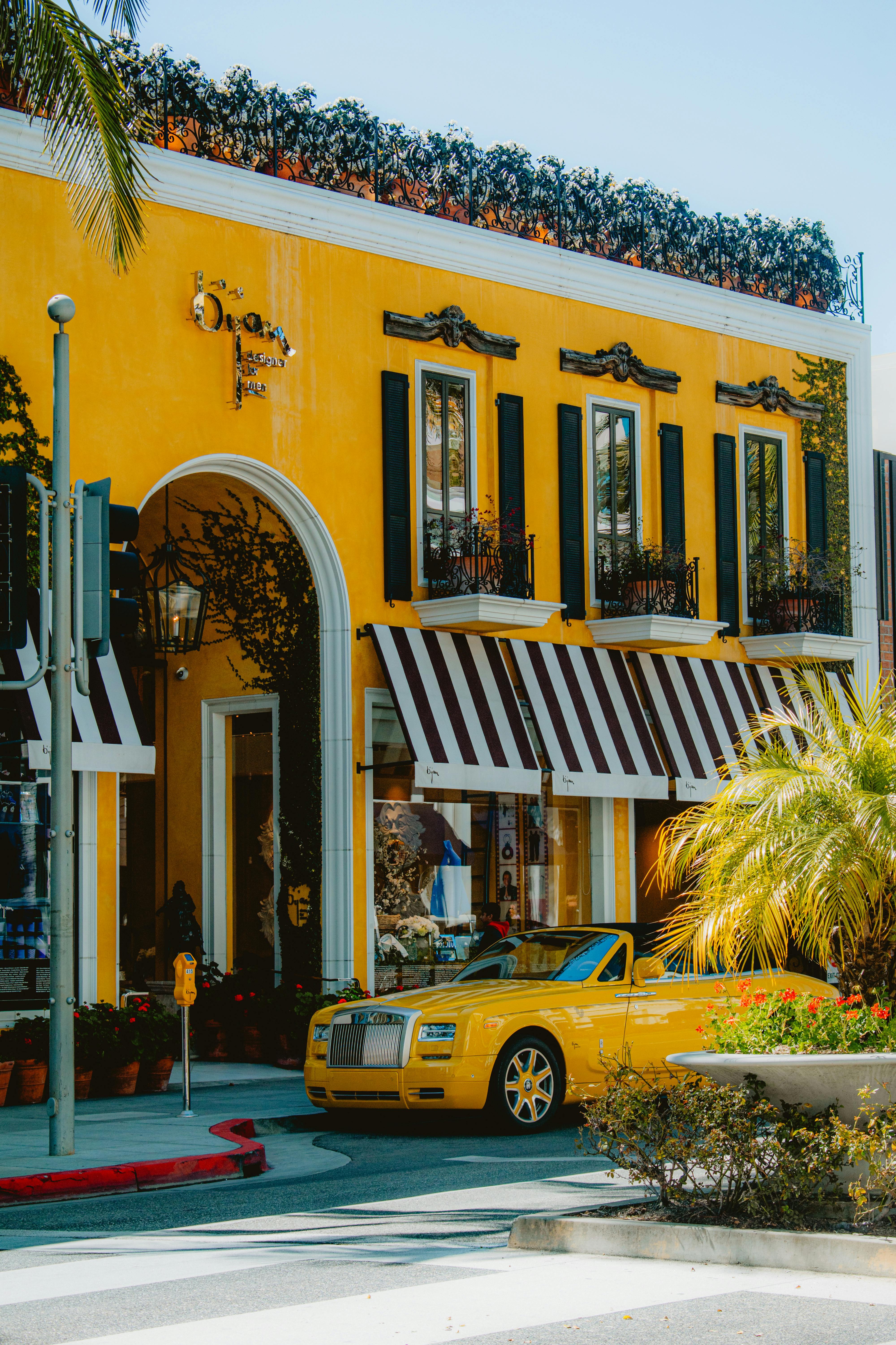 Yellow Convertible Parked outside the House of Bijan · Free Stock Photo