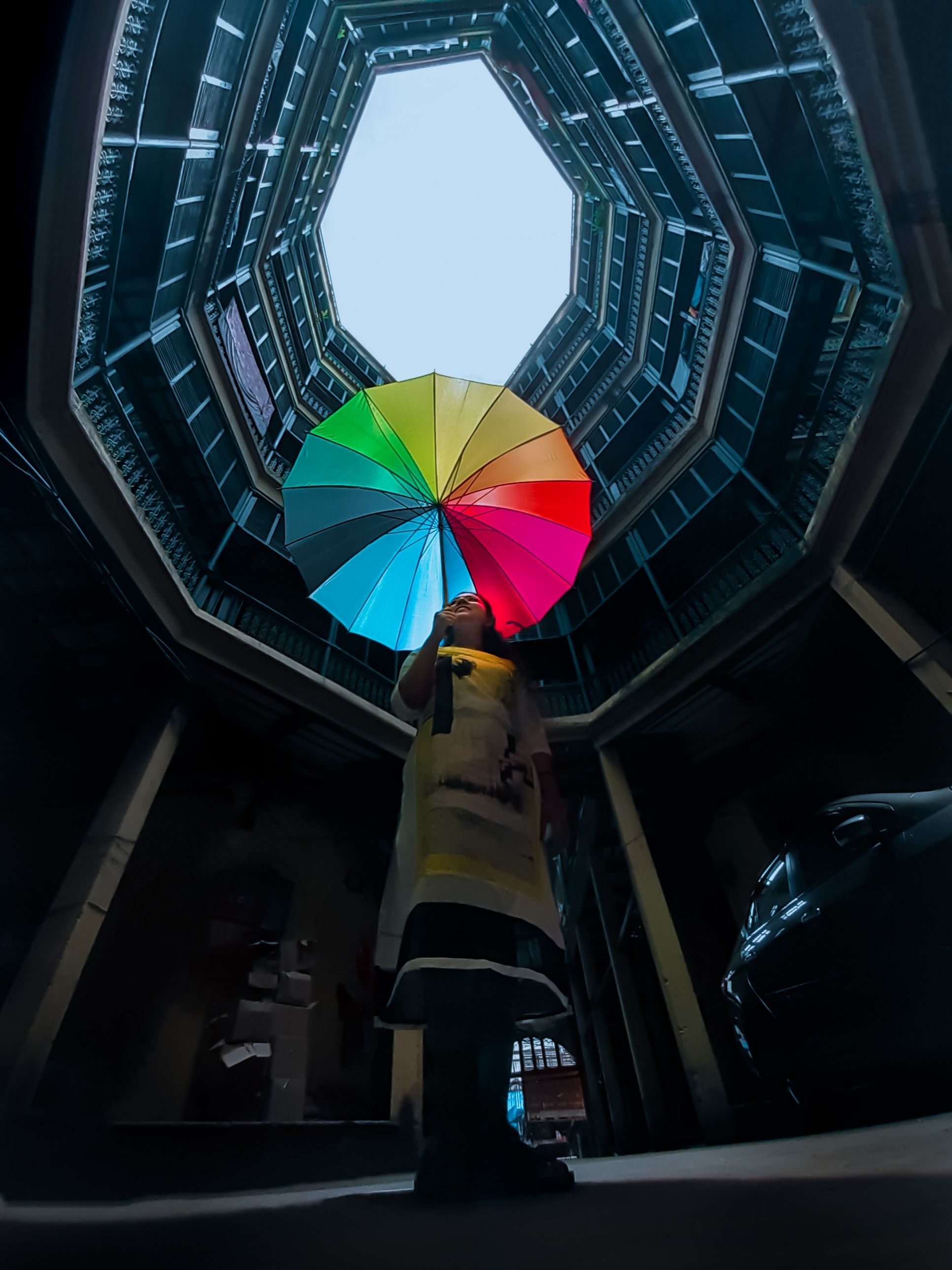 Woman under Colorful Umbrella in Courtyard of Residential Building ...
