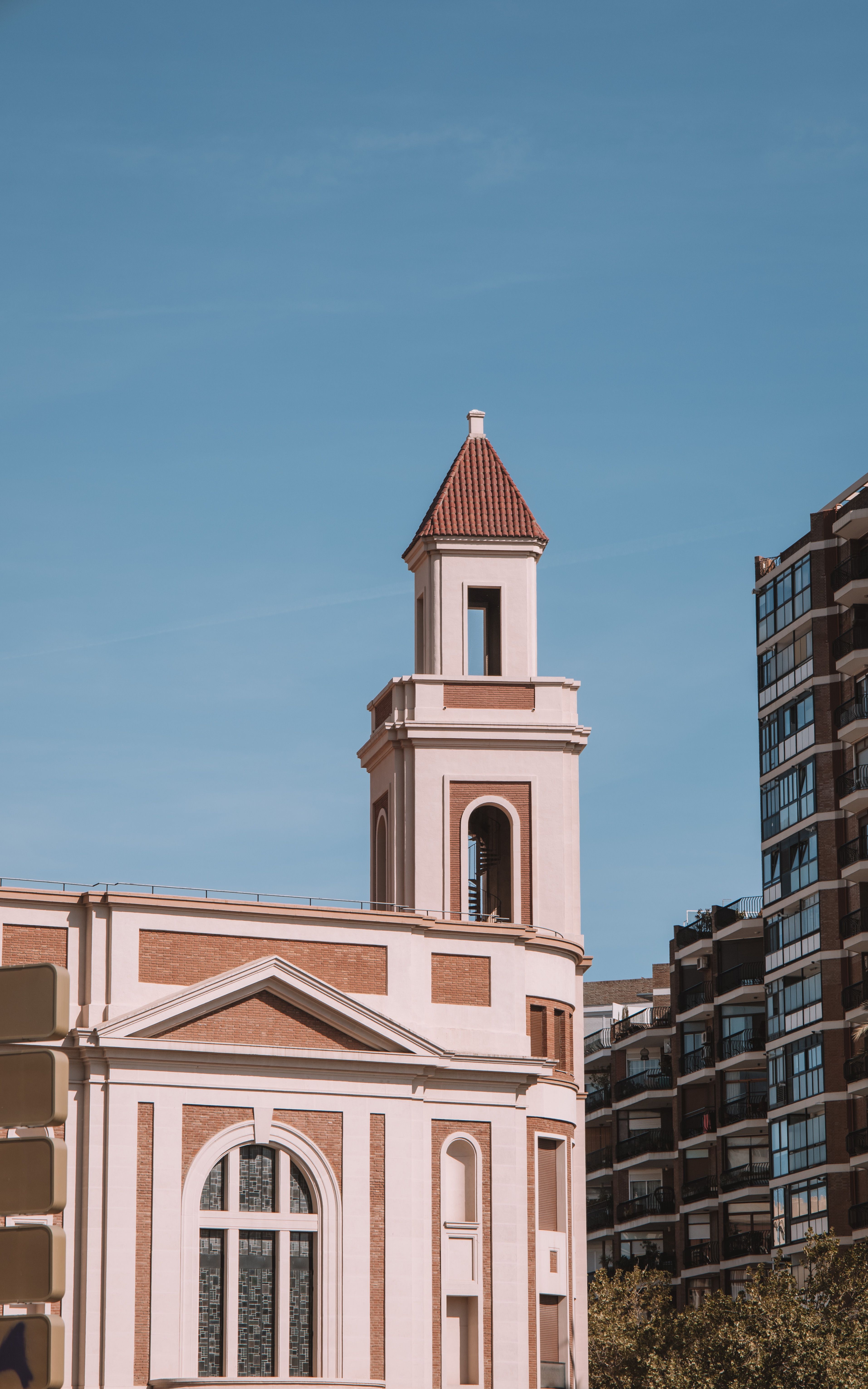 Sunlit Church with Tower in Town · Free Stock Photo