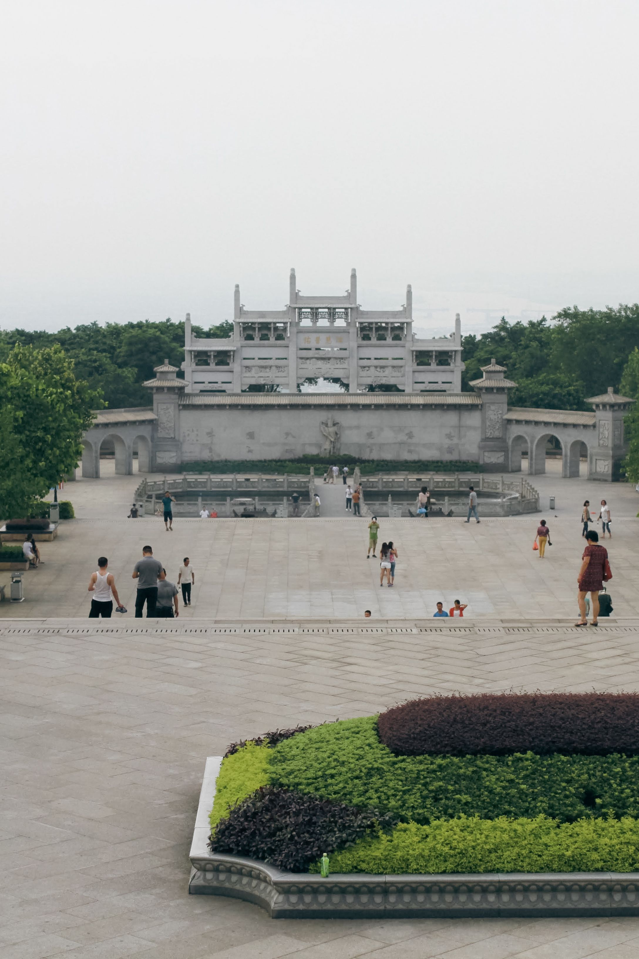 People on Pavement with Temple Building behind · Free Stock Photo