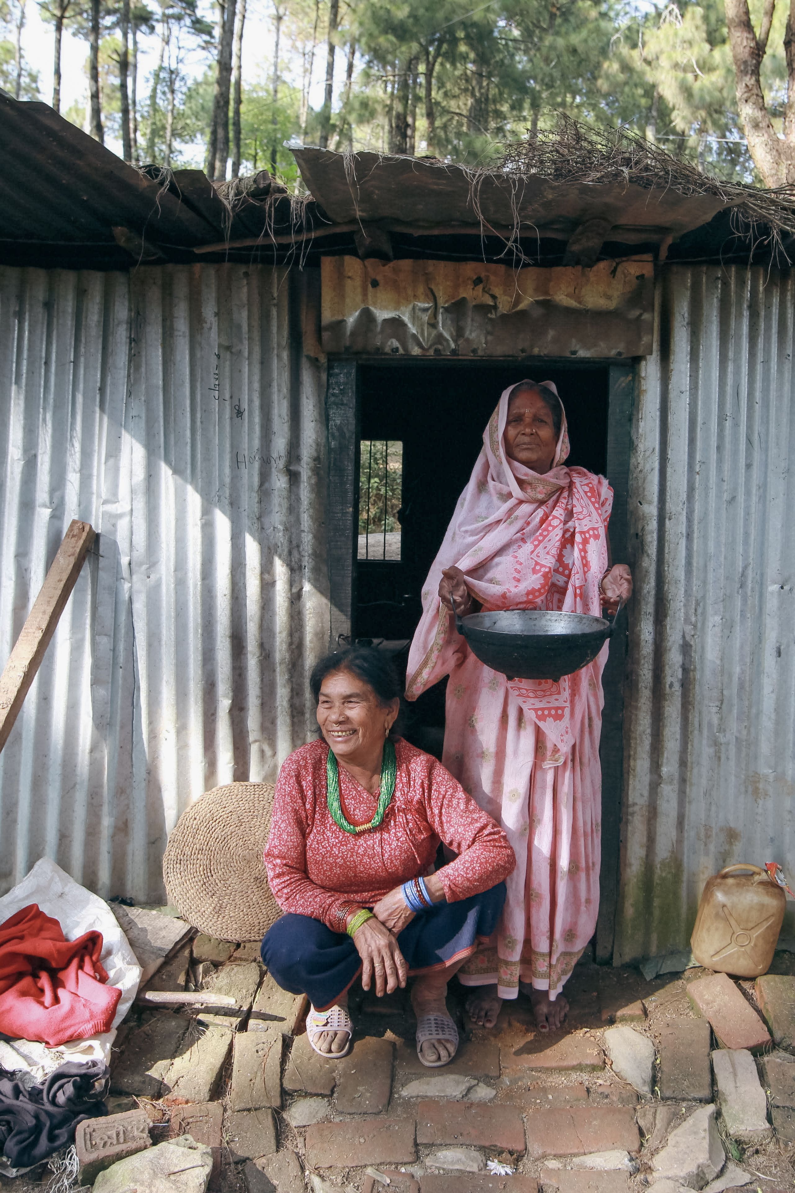 Elderly Women Posing by Doorway to Hut · Free Stock Photo
