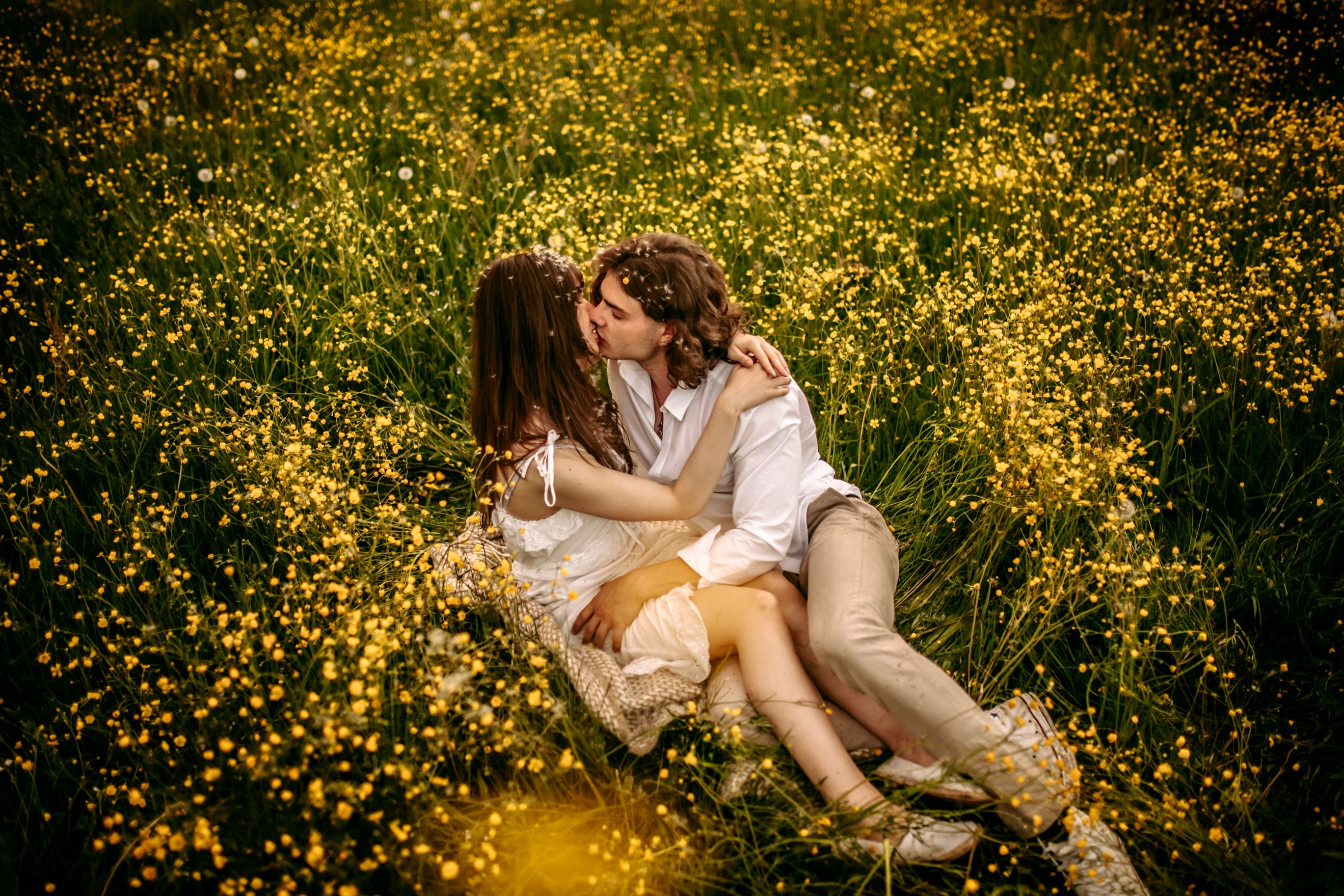 Couple Lying Down and Kissing on Meadow · Free Stock Photo