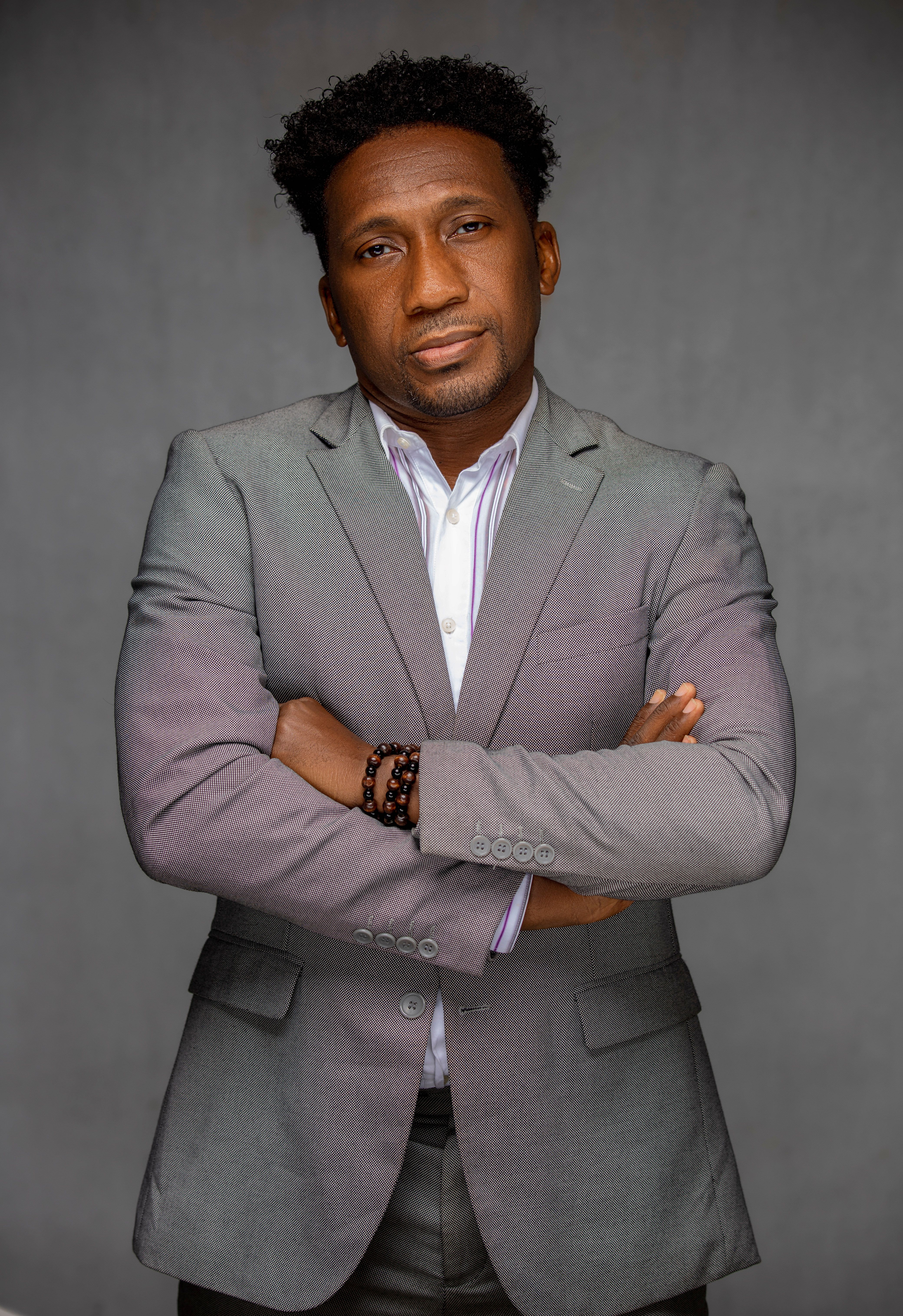 Portrait of a Male Model Wearing a Gray Jacket Standing with Crossed ...