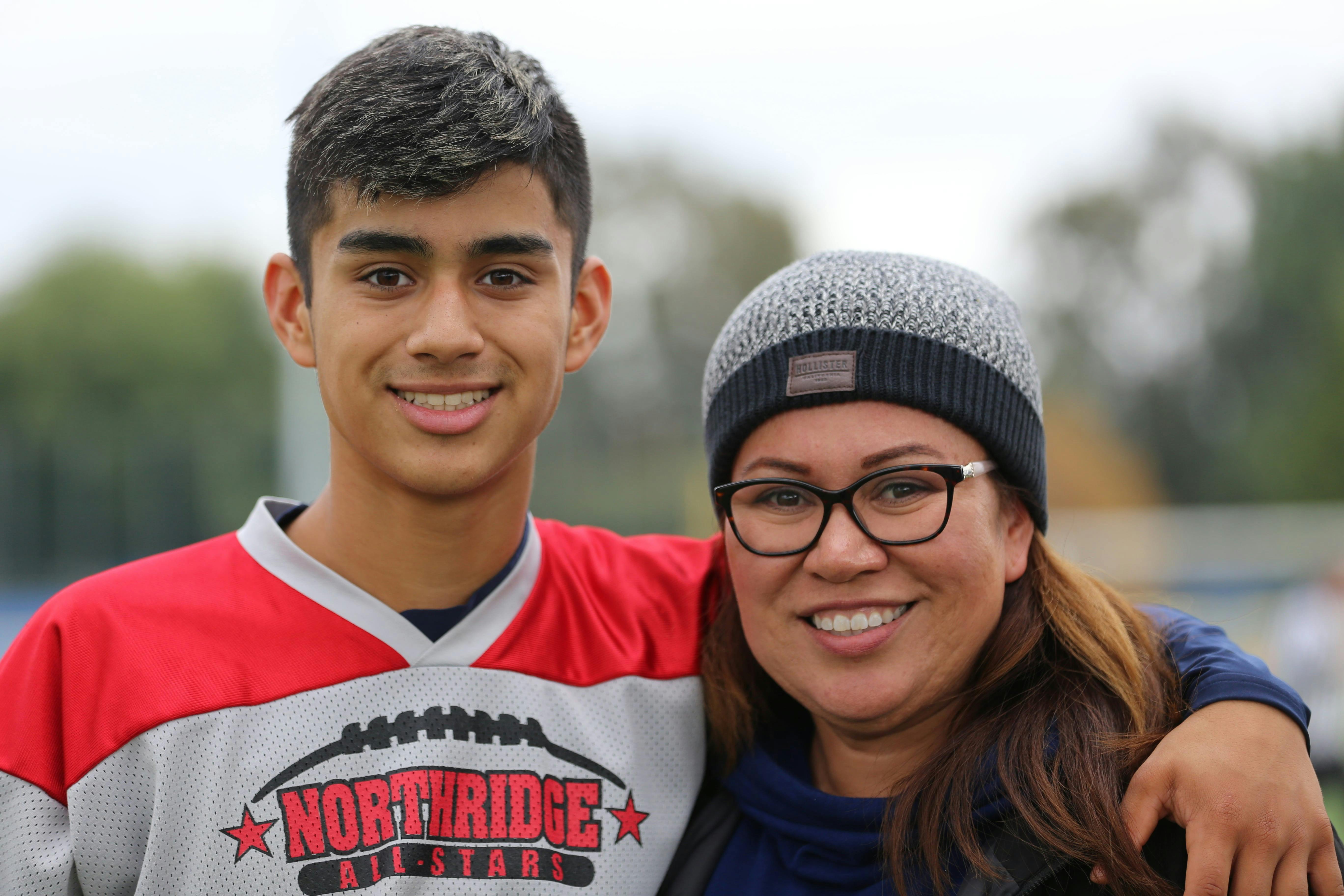 Young Athlete Posing with his Mother · Free Stock Photo