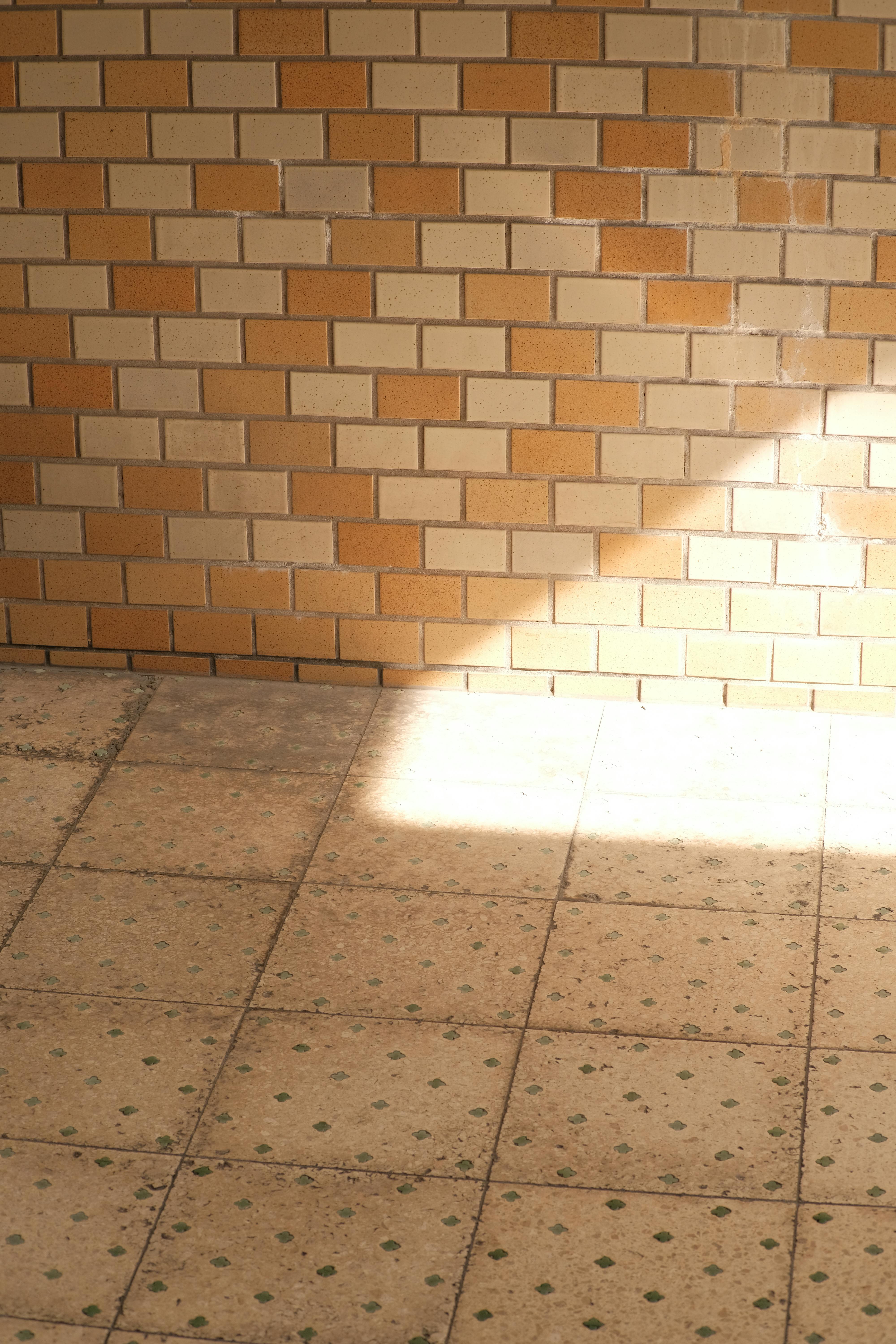 A Beam on Light Shining on a Wall and Floor with Tiles · Free Stock Photo