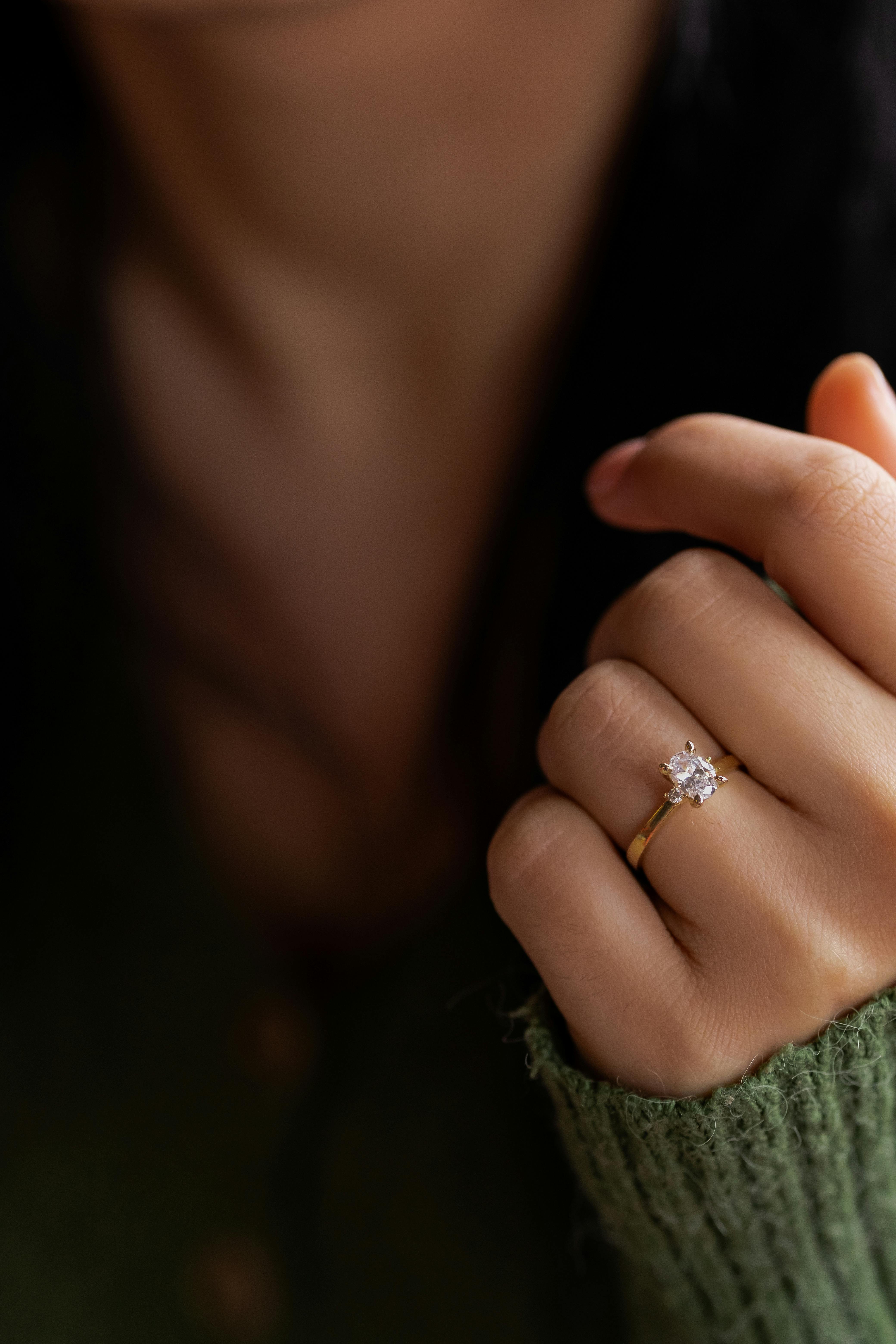 Hands Arranging Rings on Display · Free Stock Photo