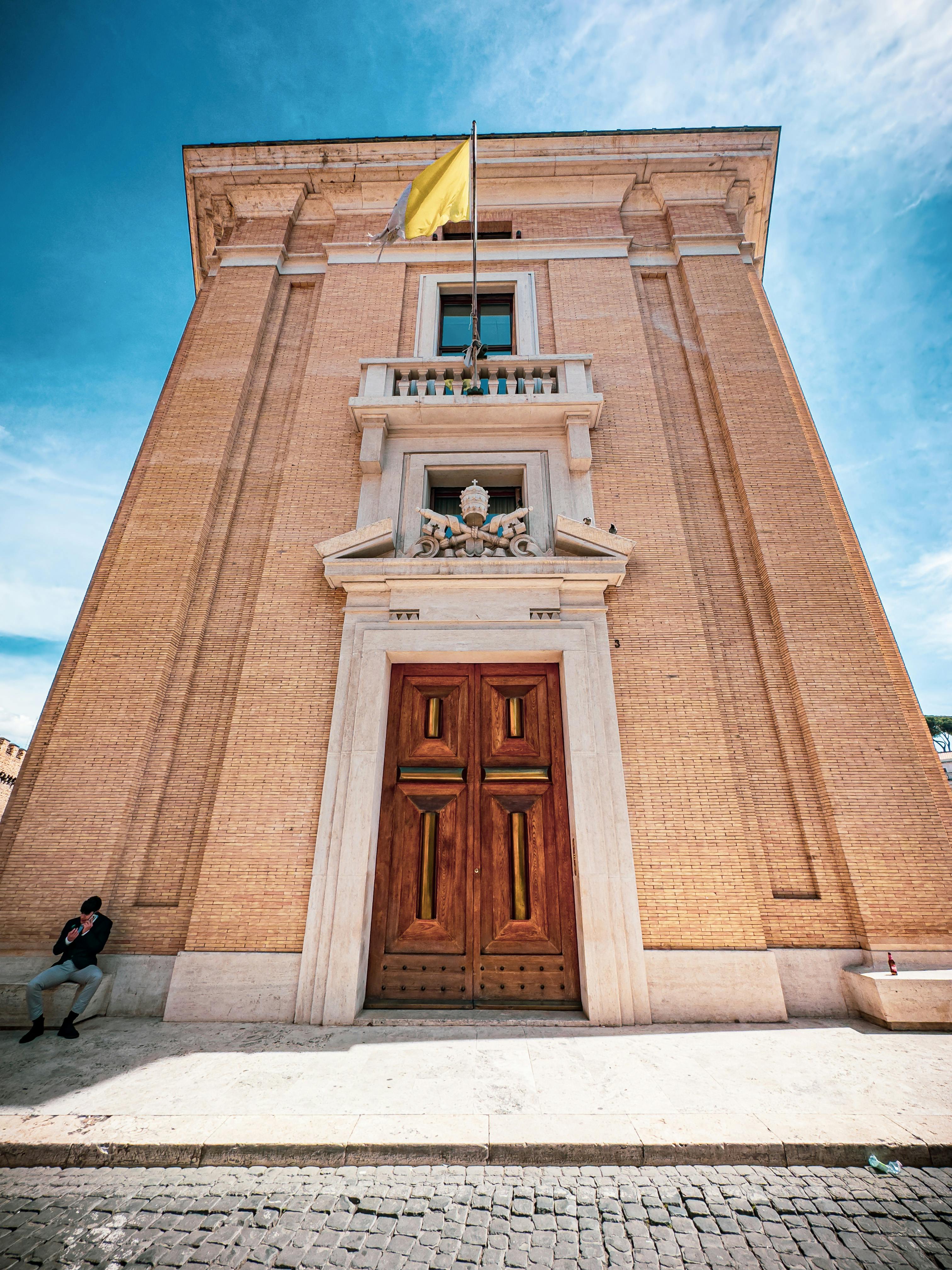 Building with Papal Regalia above the Entrance on a Cobblestone Street ...