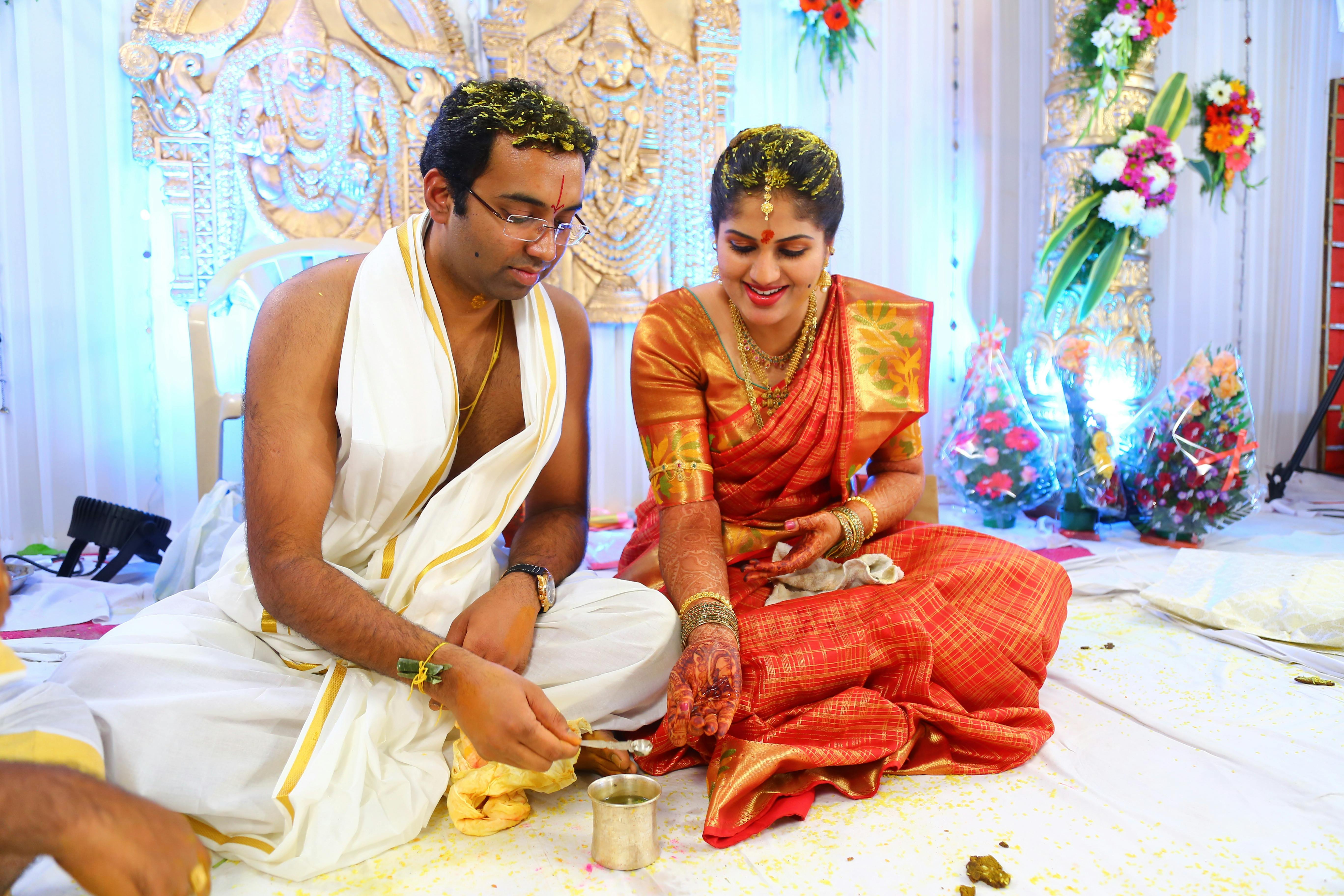 Smiling Woman and Man Sitting in Traditional Clothing · Free Stock Photo
