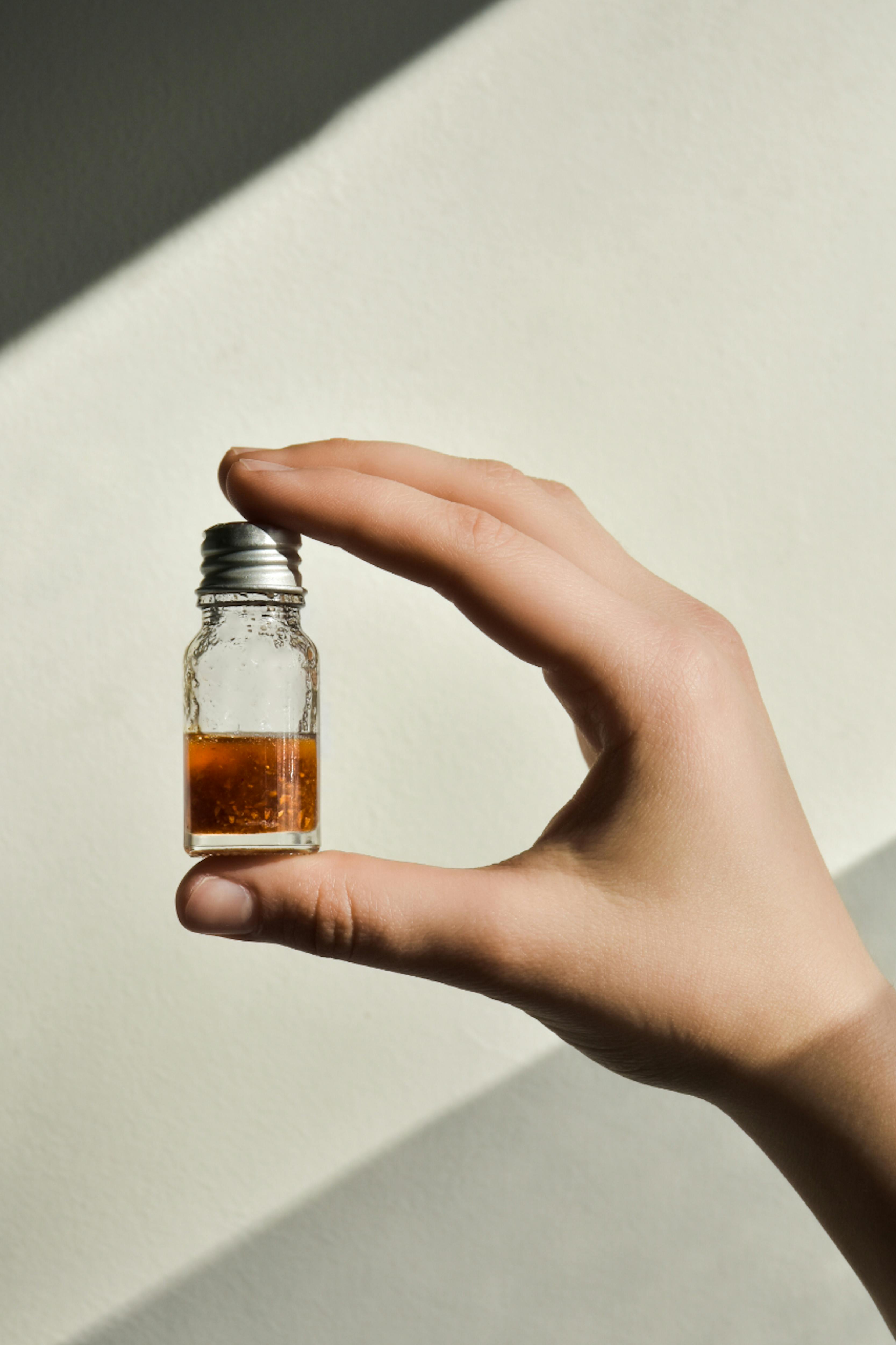 Hand Holding Vial with Liquid · Free Stock Photo