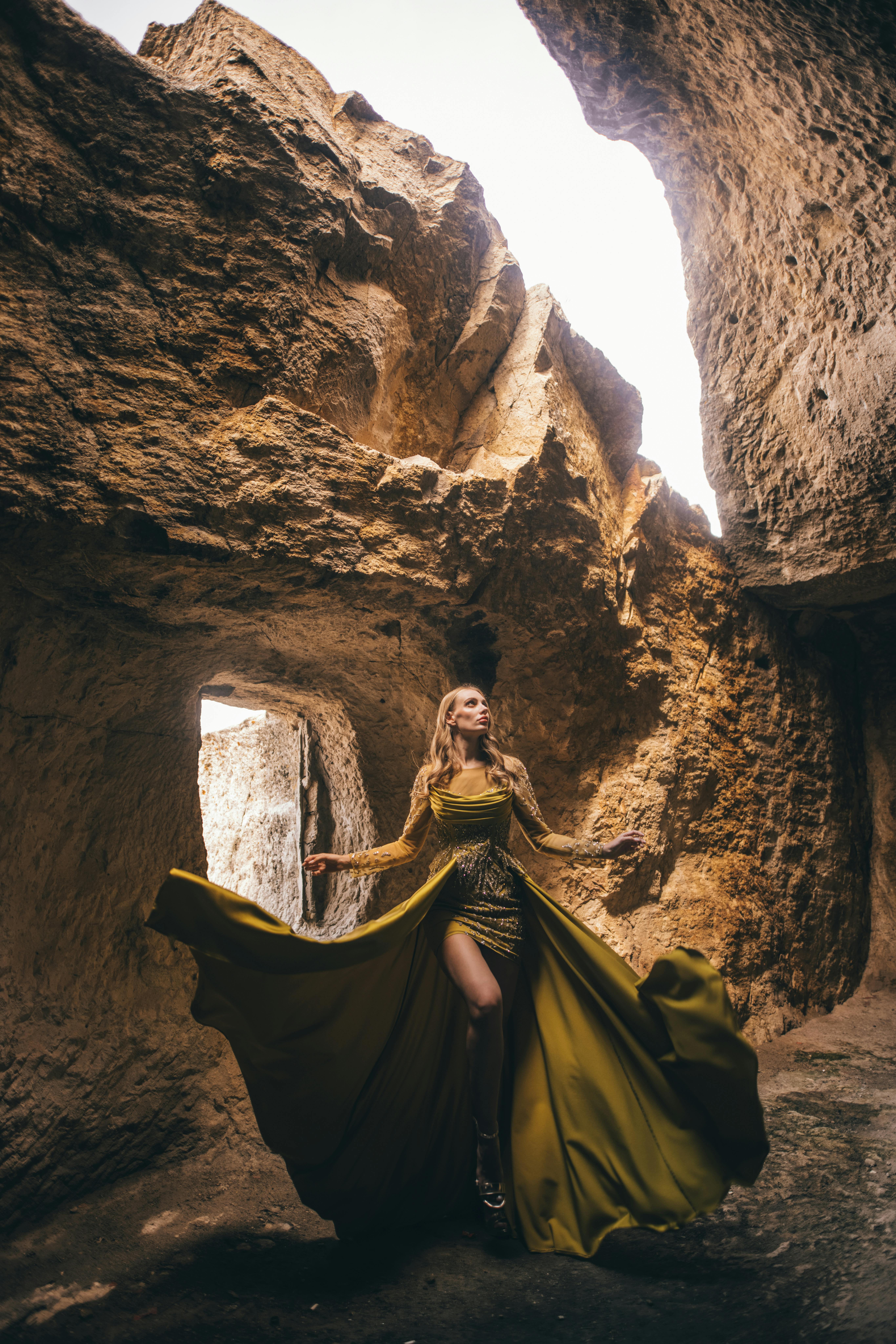 Woman in Yellow Dress among Rocks · Free Stock Photo