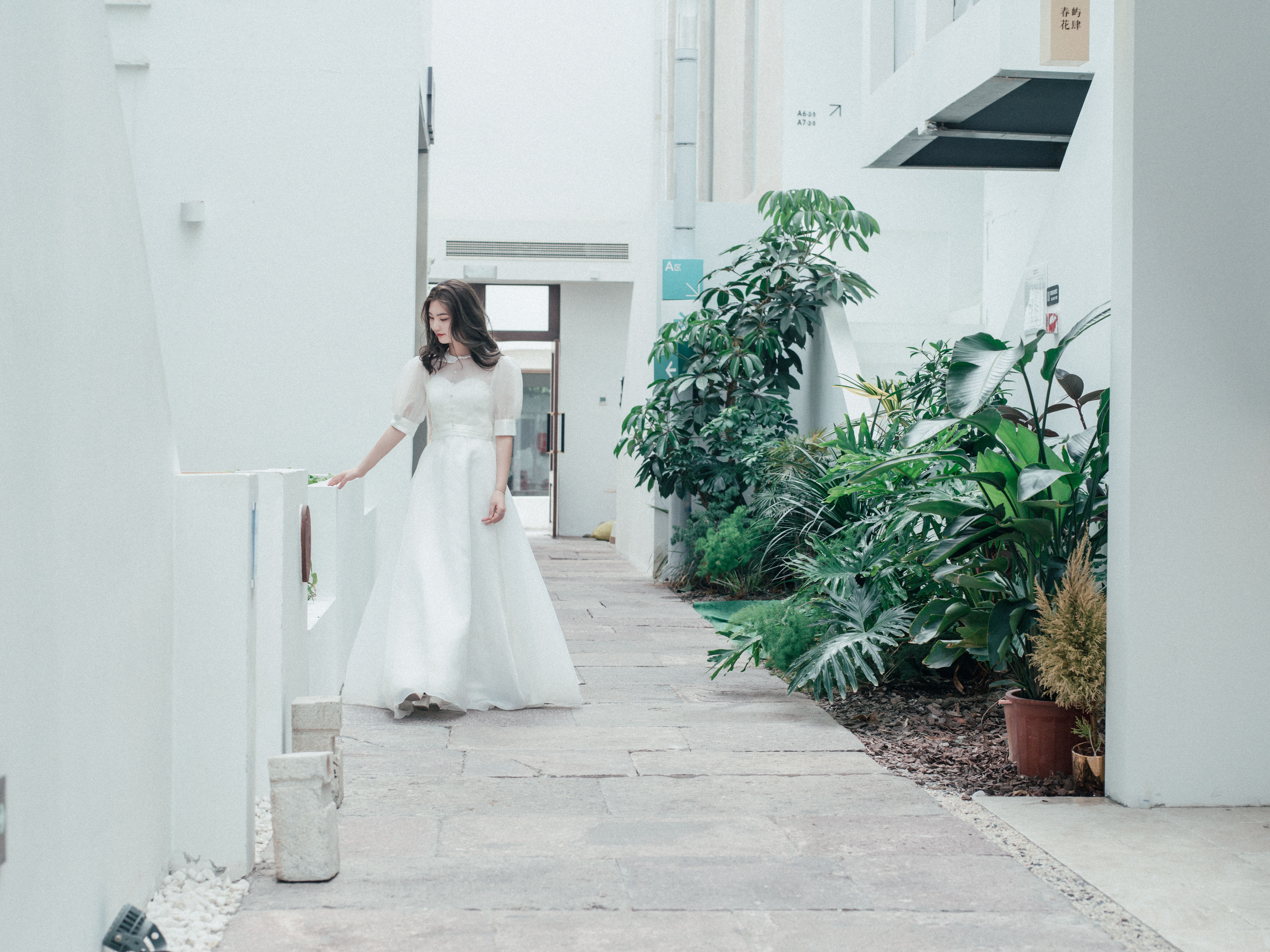 Bride in Wedding Dress Posing among White Buildings in Town · Free ...