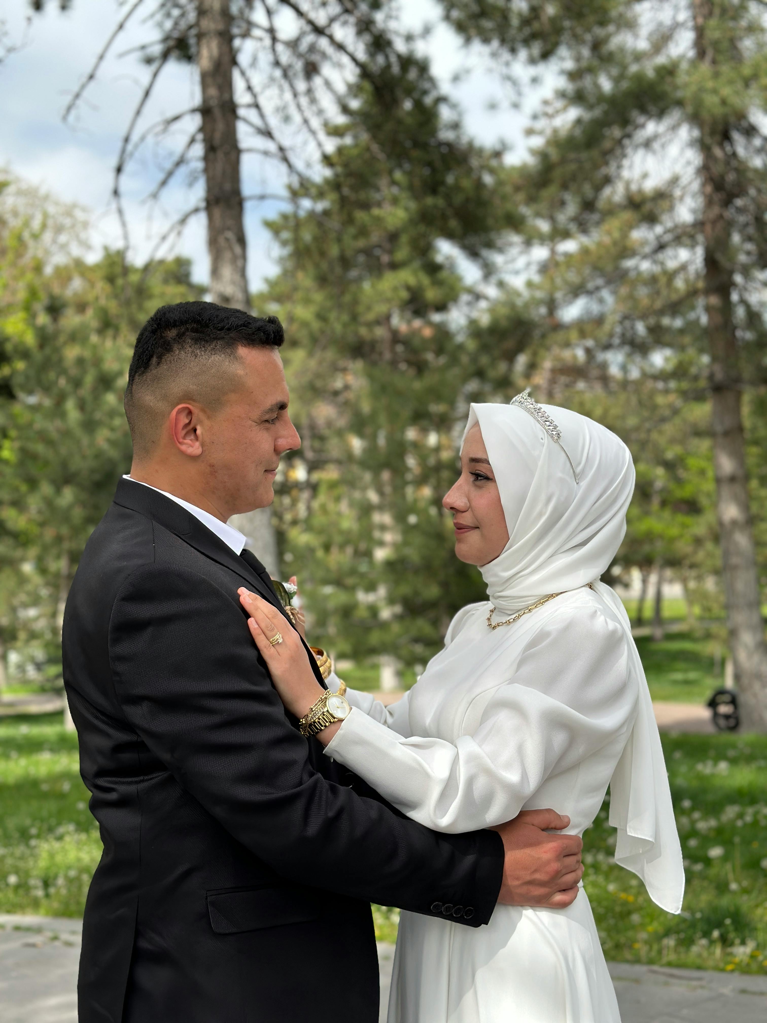 Photo of a Standing Wedding Couple Wearing Traditional Wedding Dress ...