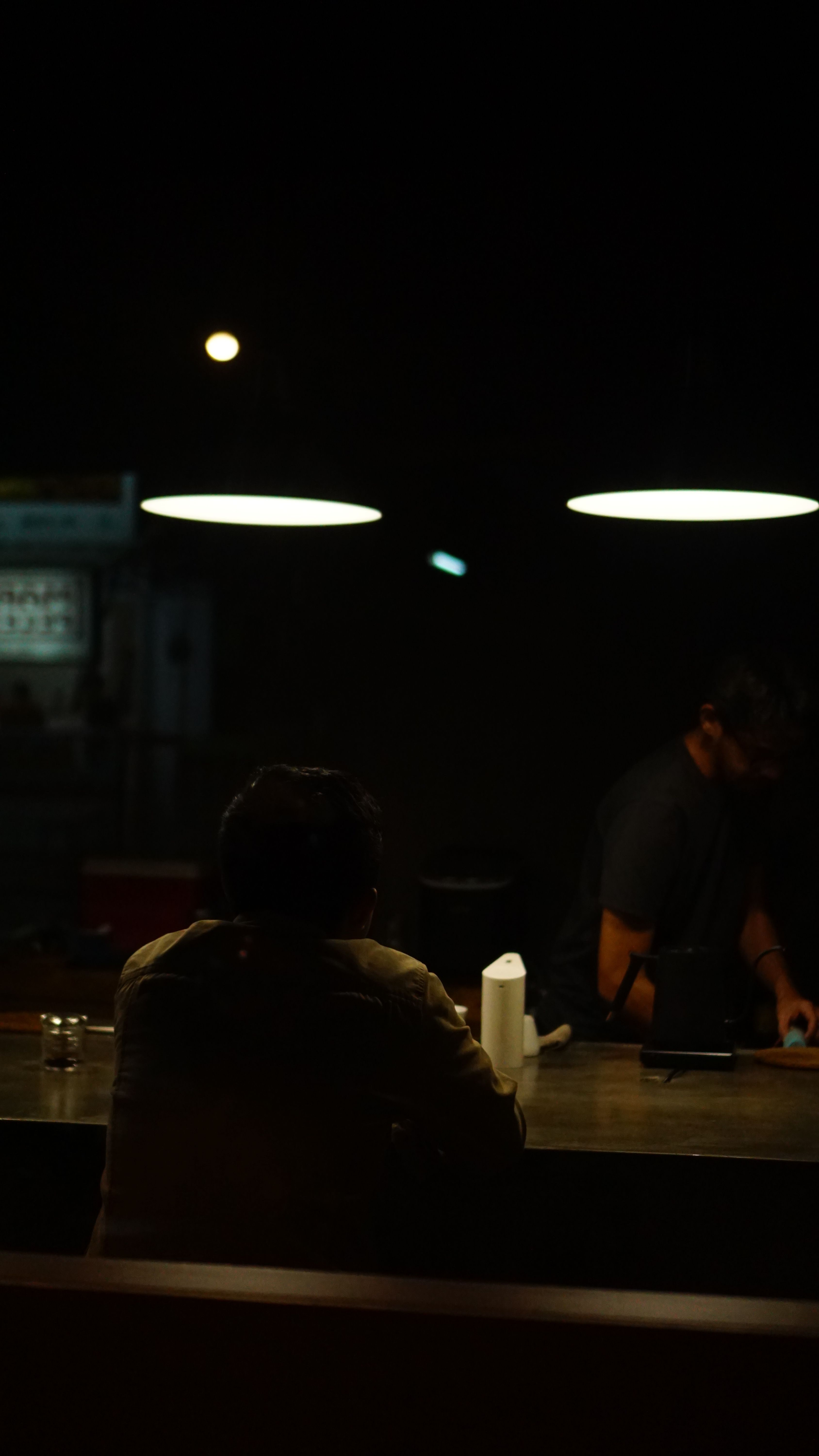 People Sitting in a Dark Bar · Free Stock Photo