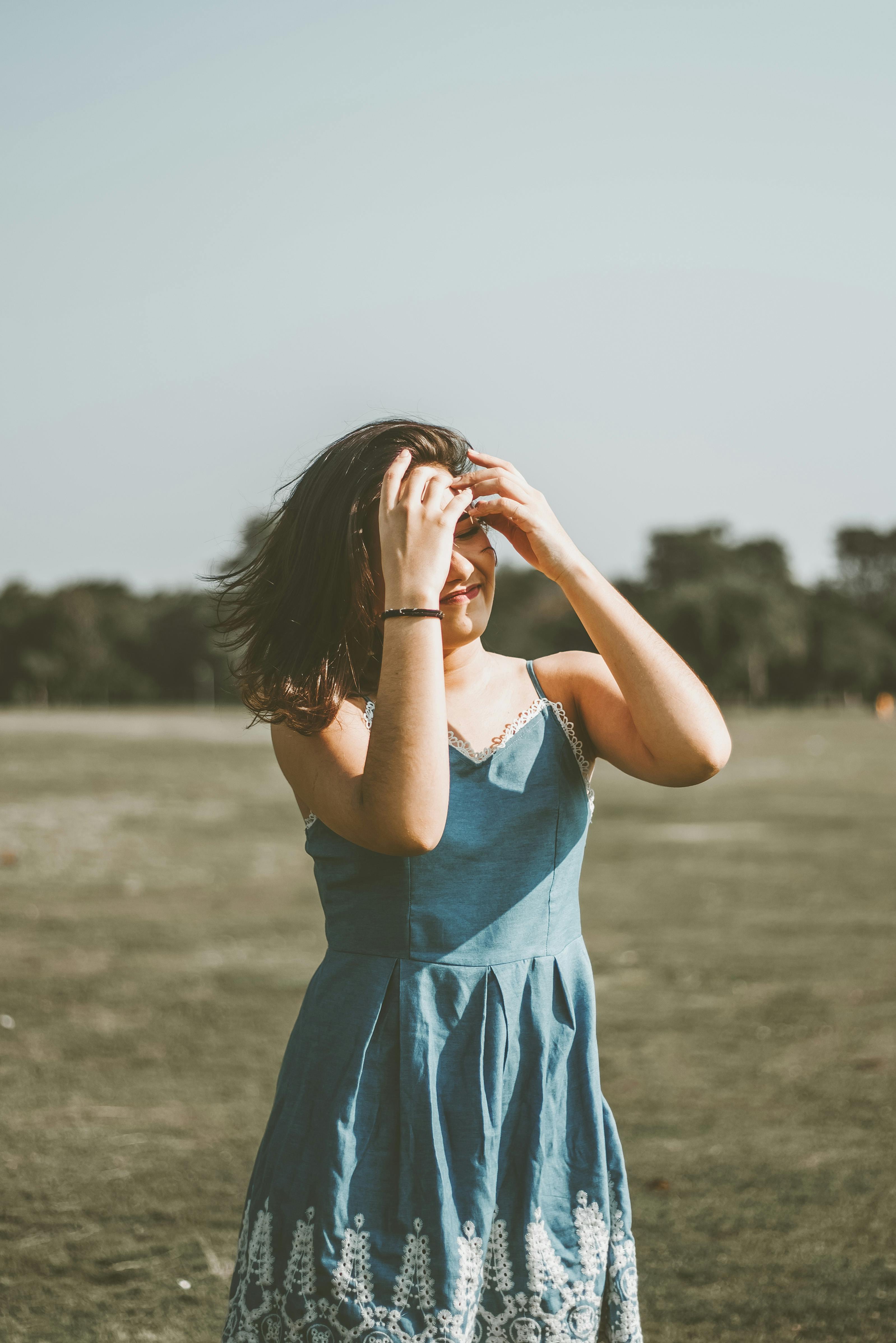Woman Standing in Sunlight on the Pavement · Free Stock Photo