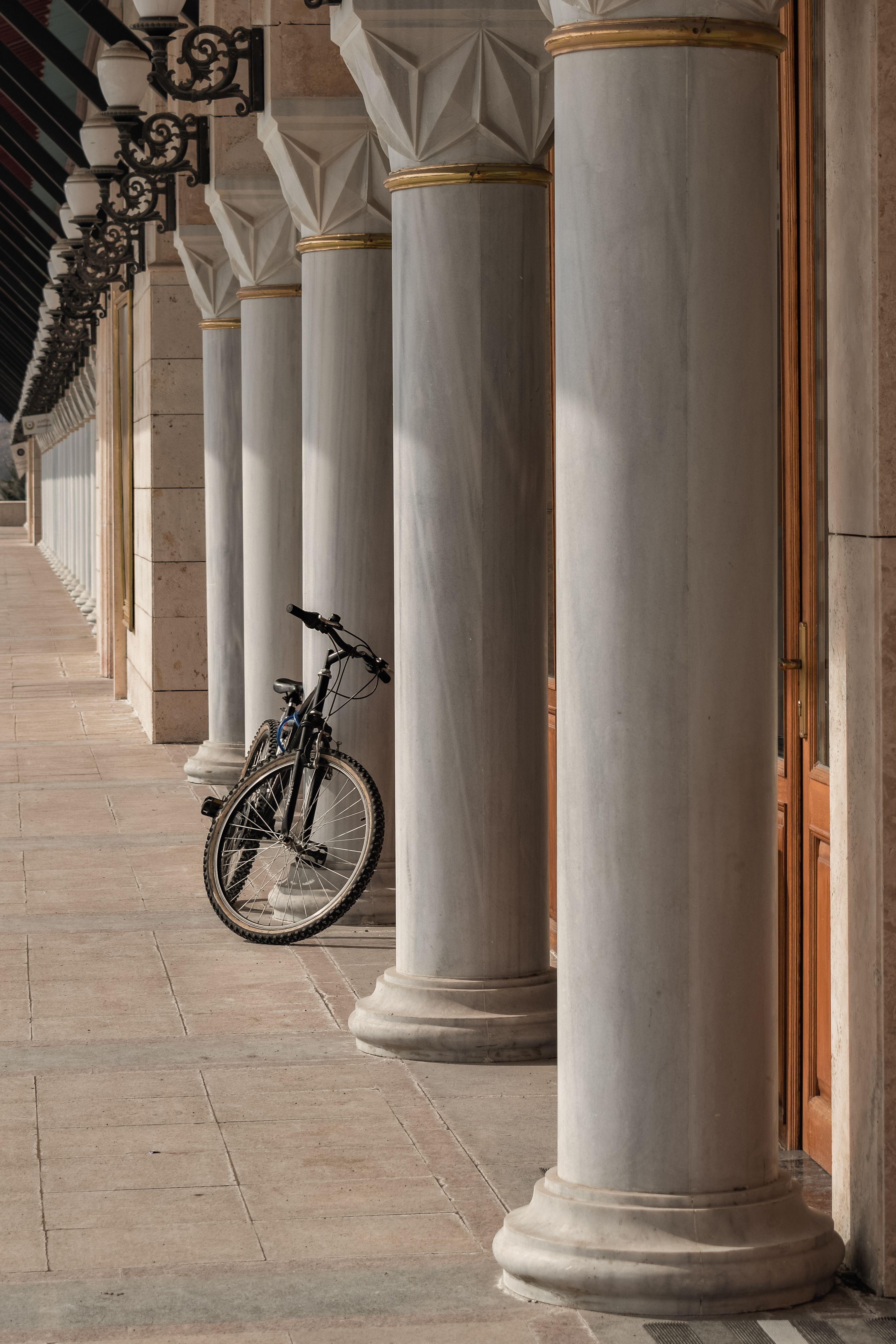 Bicycle Leaning against a Column · Free Stock Photo