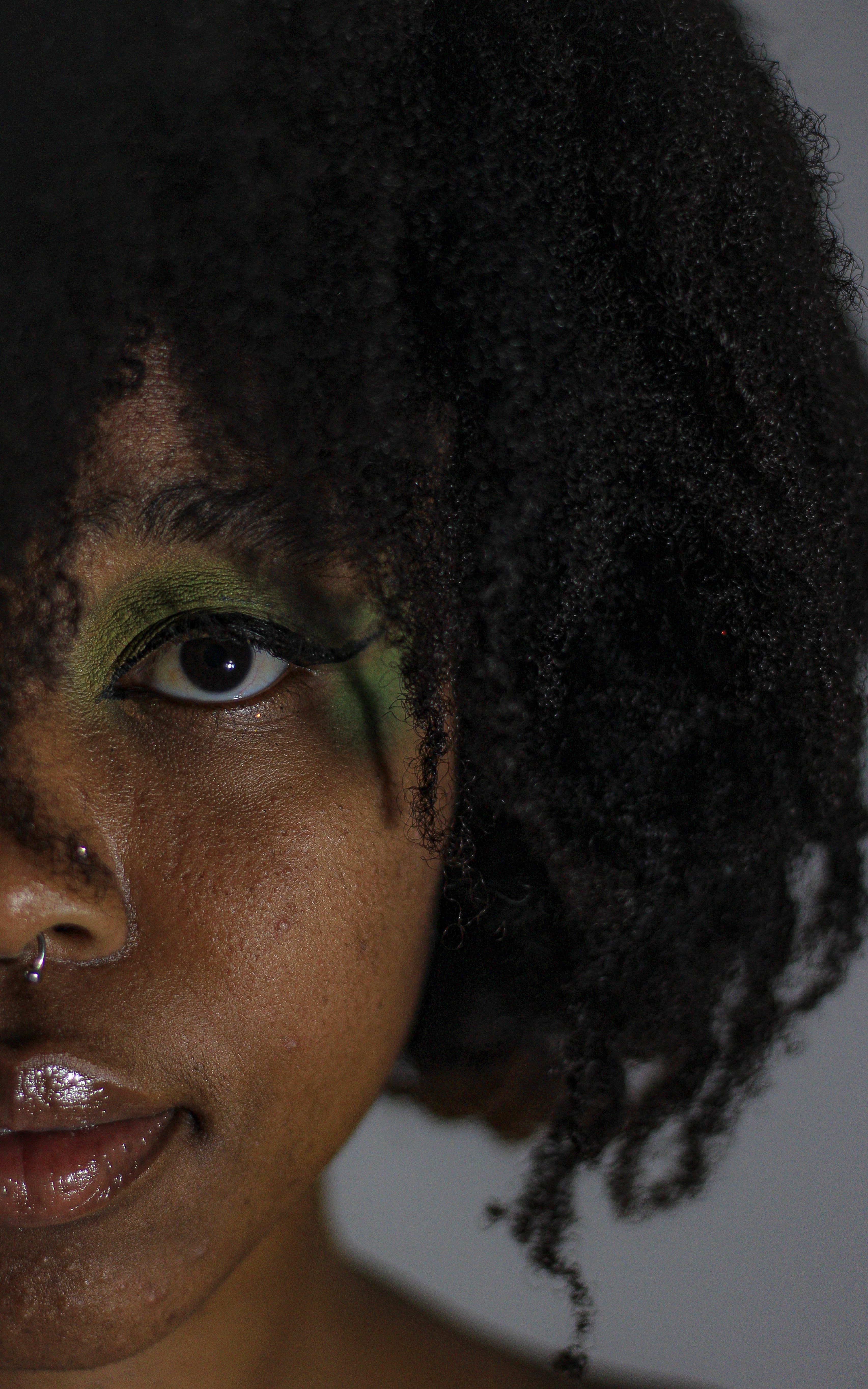 Close-up Half Face Portrait of a Young Woman Wearing Green Eye Makeup ...