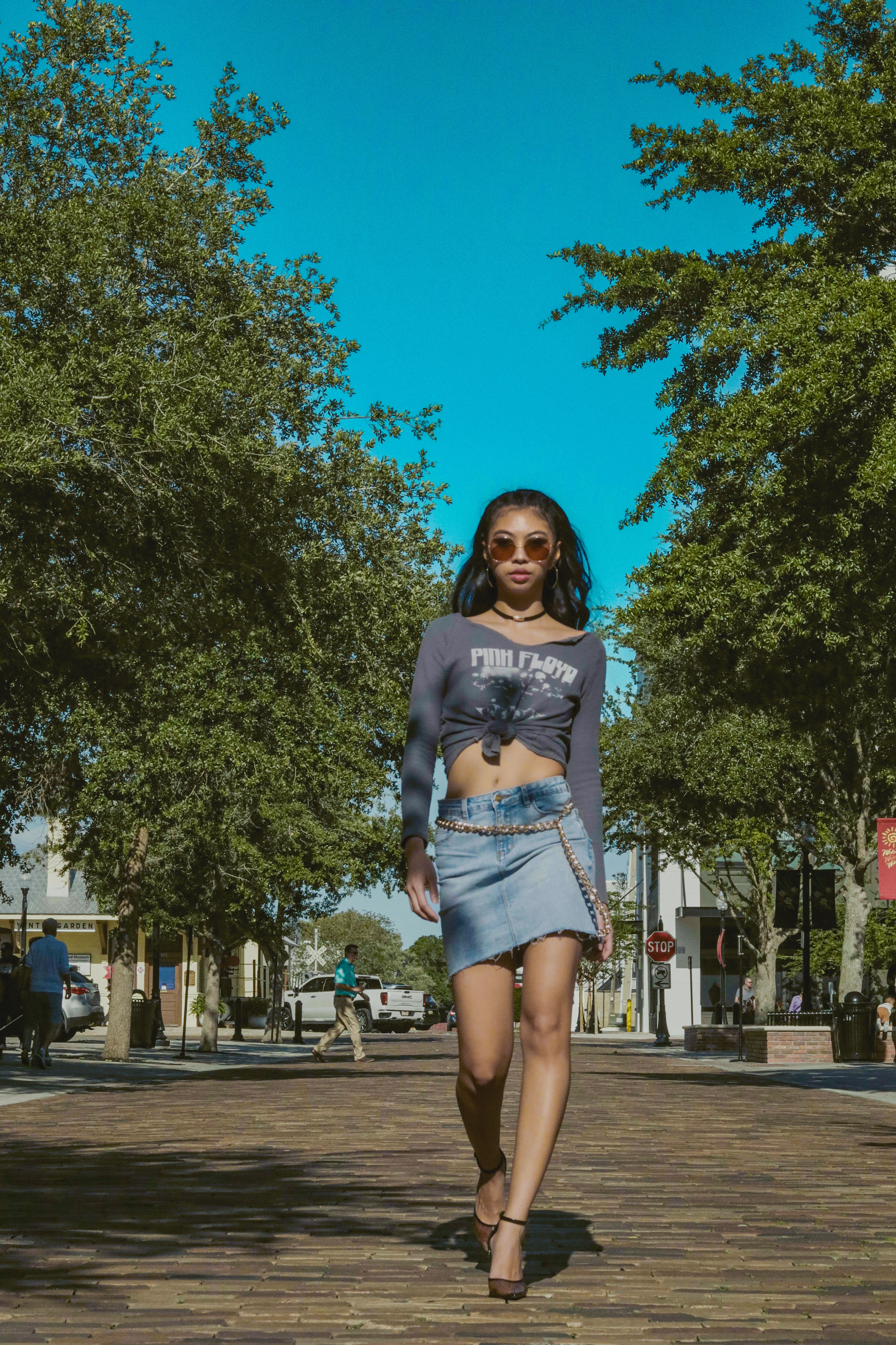 Model in Jean Skirt Walking at Park · Free Stock Photo