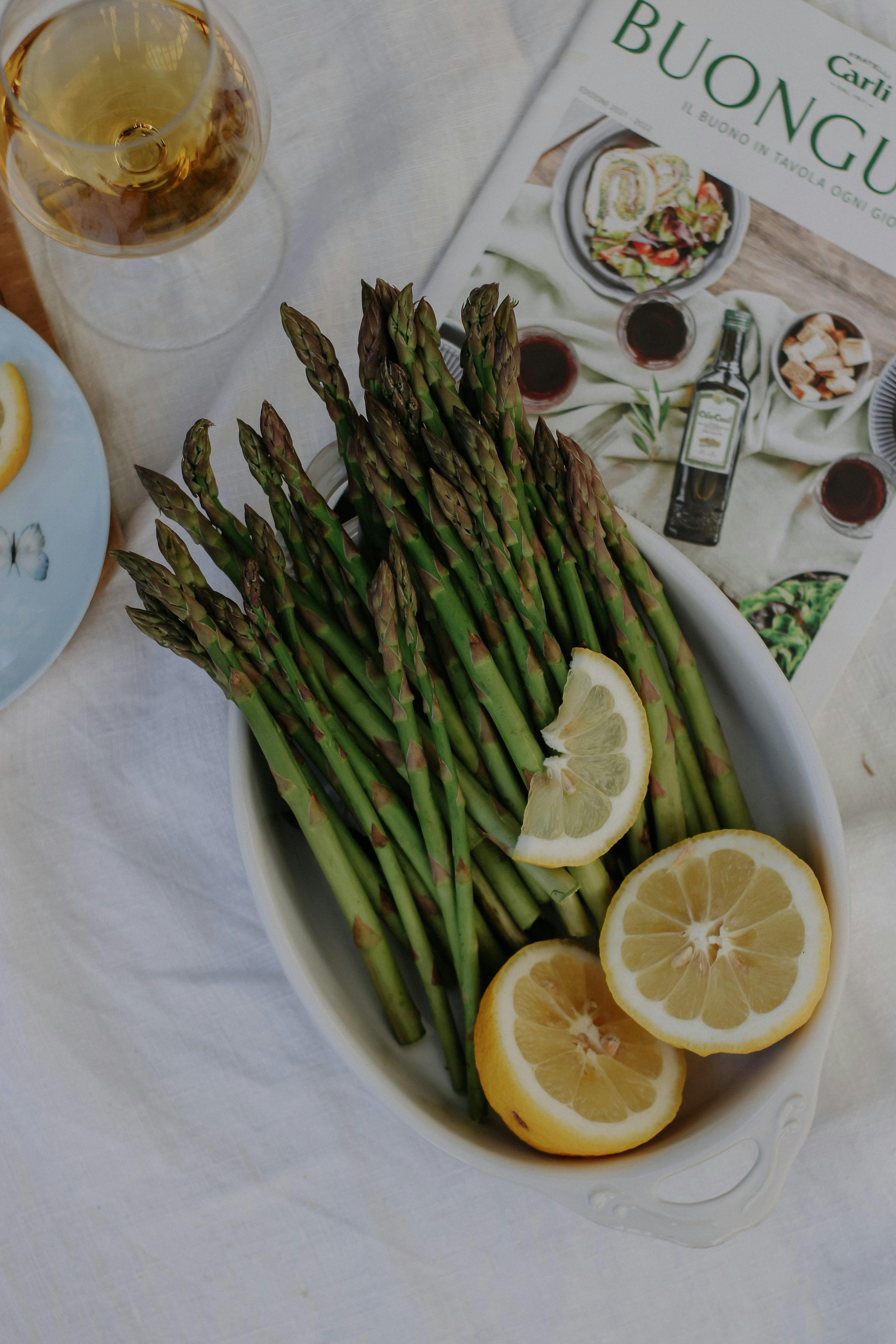 Asparagus with Lemon on Plate on Table · Free Stock Photo