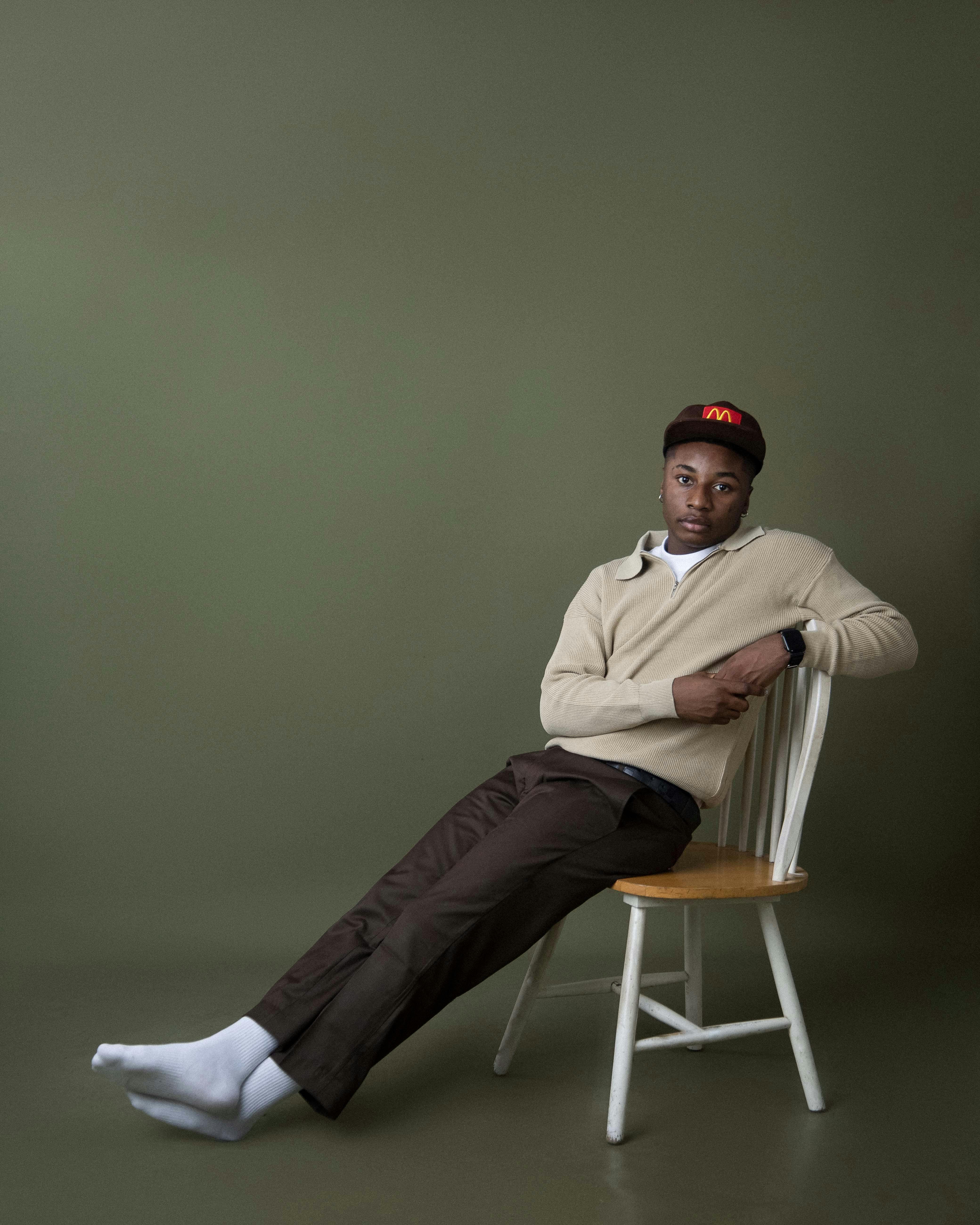 Profile of Person Sitting on Chair in Yellow Setting · Free Stock Photo
