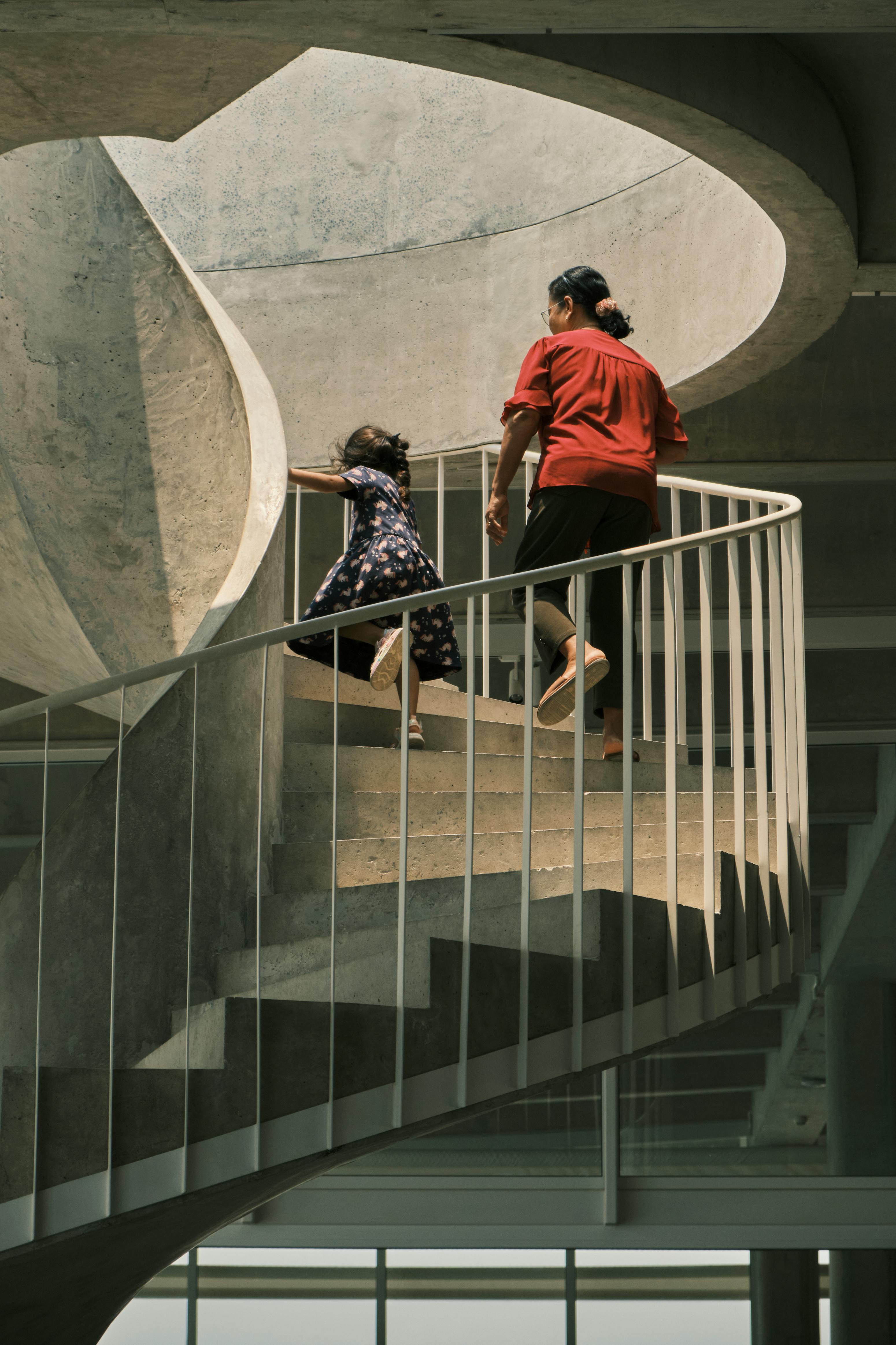 Photo of a Woman and a Girl Going Up the Stairs · Free Stock Photo