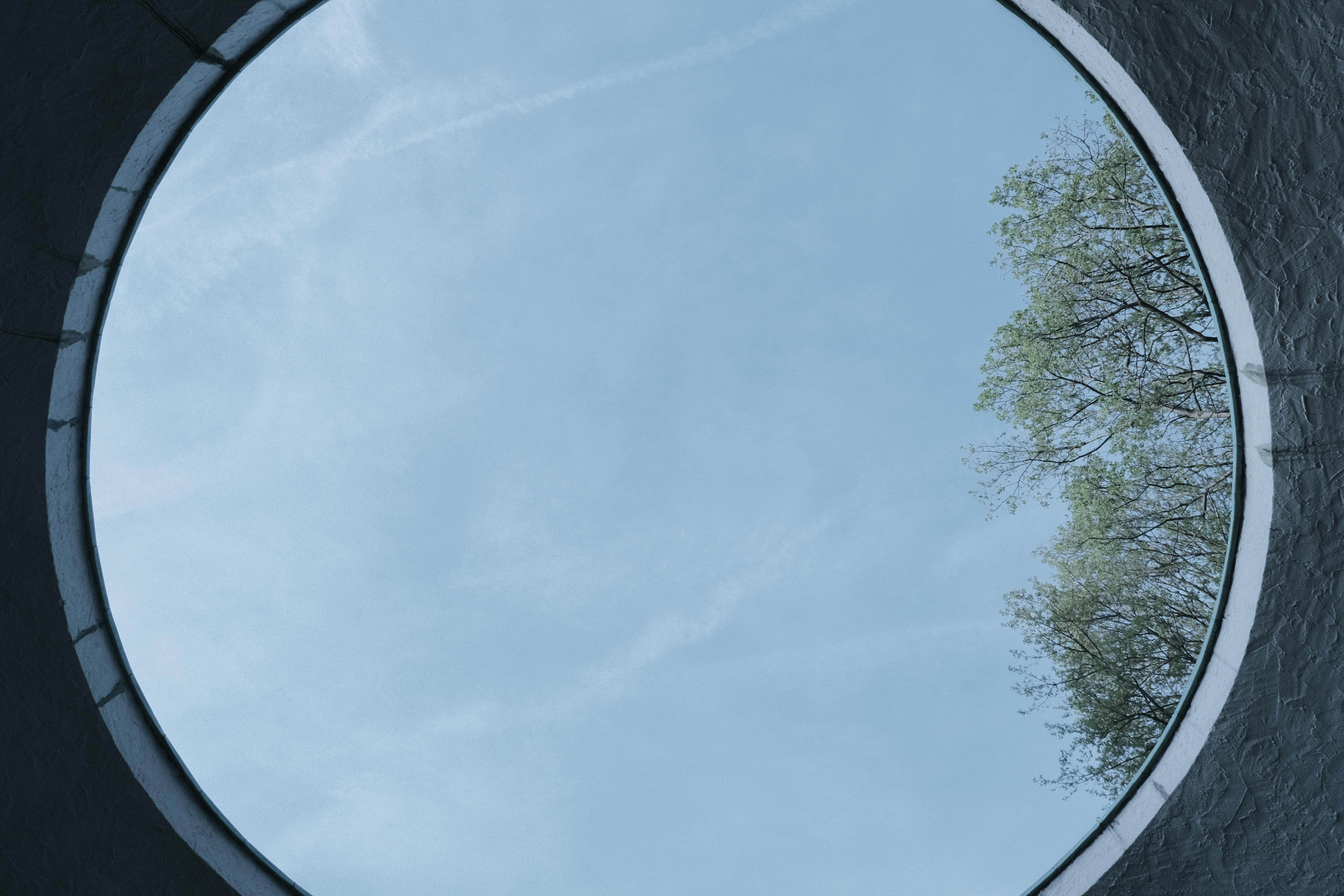 Photo of the Sky Seen Through a Circle Roof Window · Free Stock Photo
