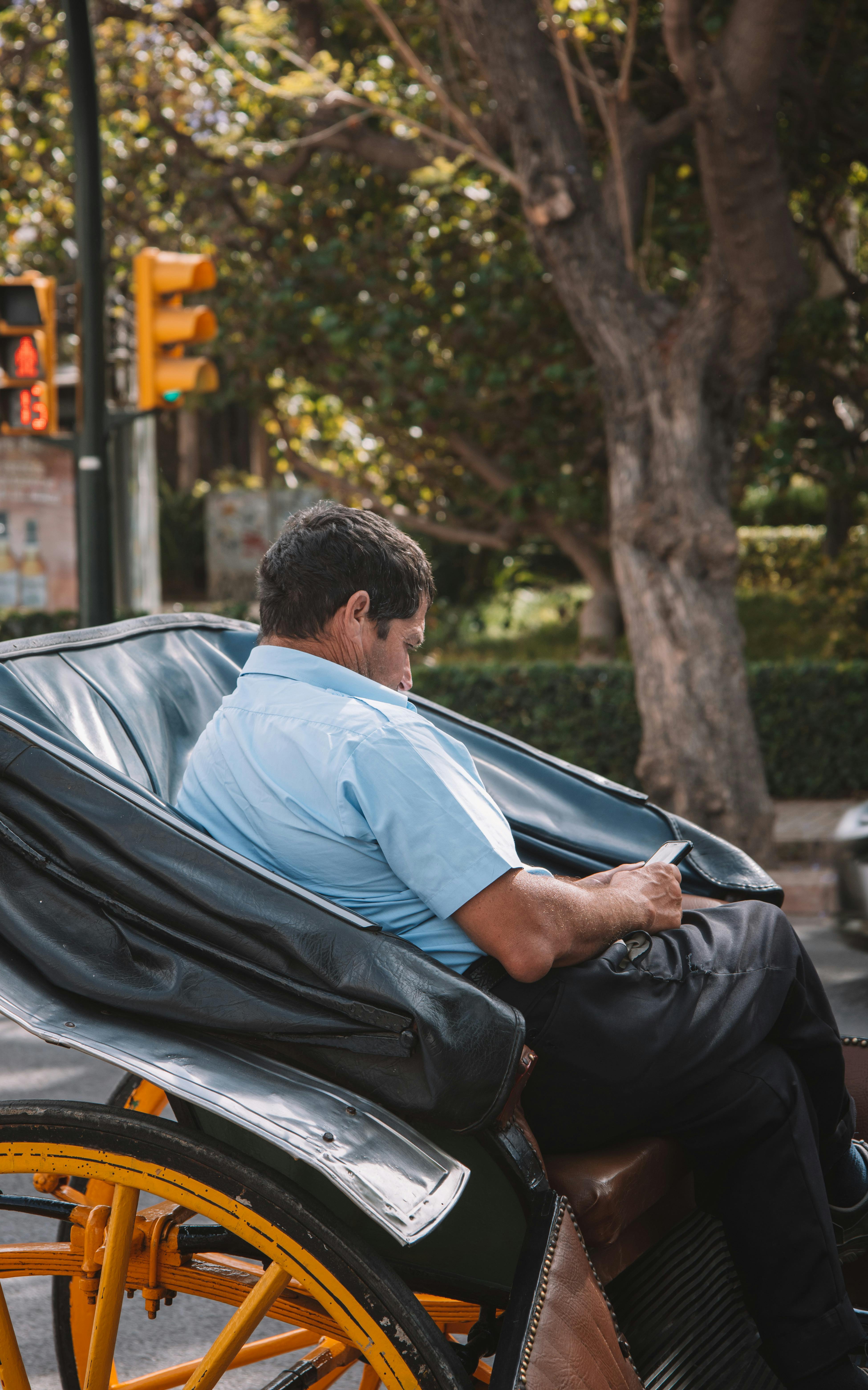 Man Sitting on a Parked Golf Cart · Free Stock Photo