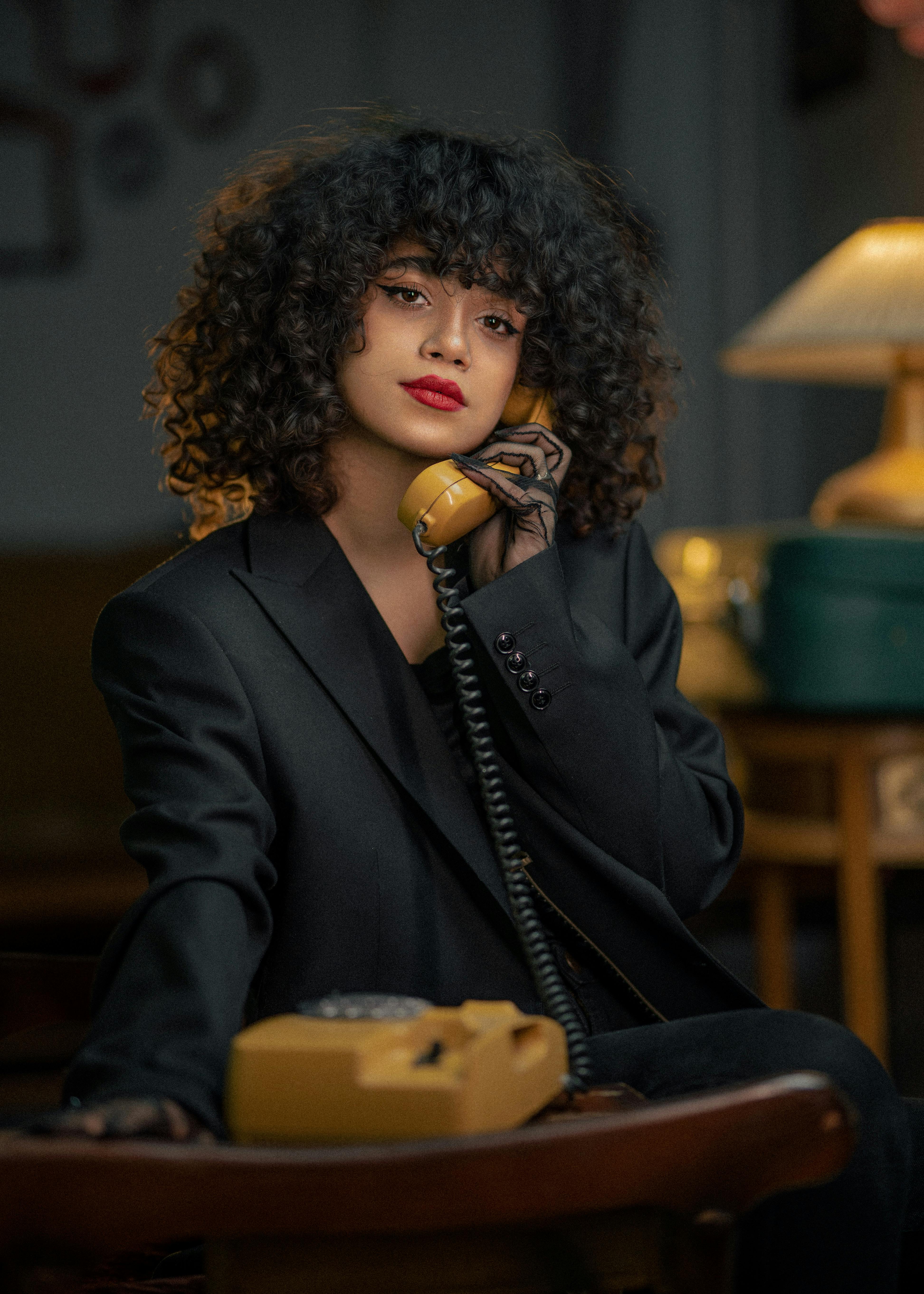 Woman with Curly Hair Talking on Corded Phone · Free Stock Photo