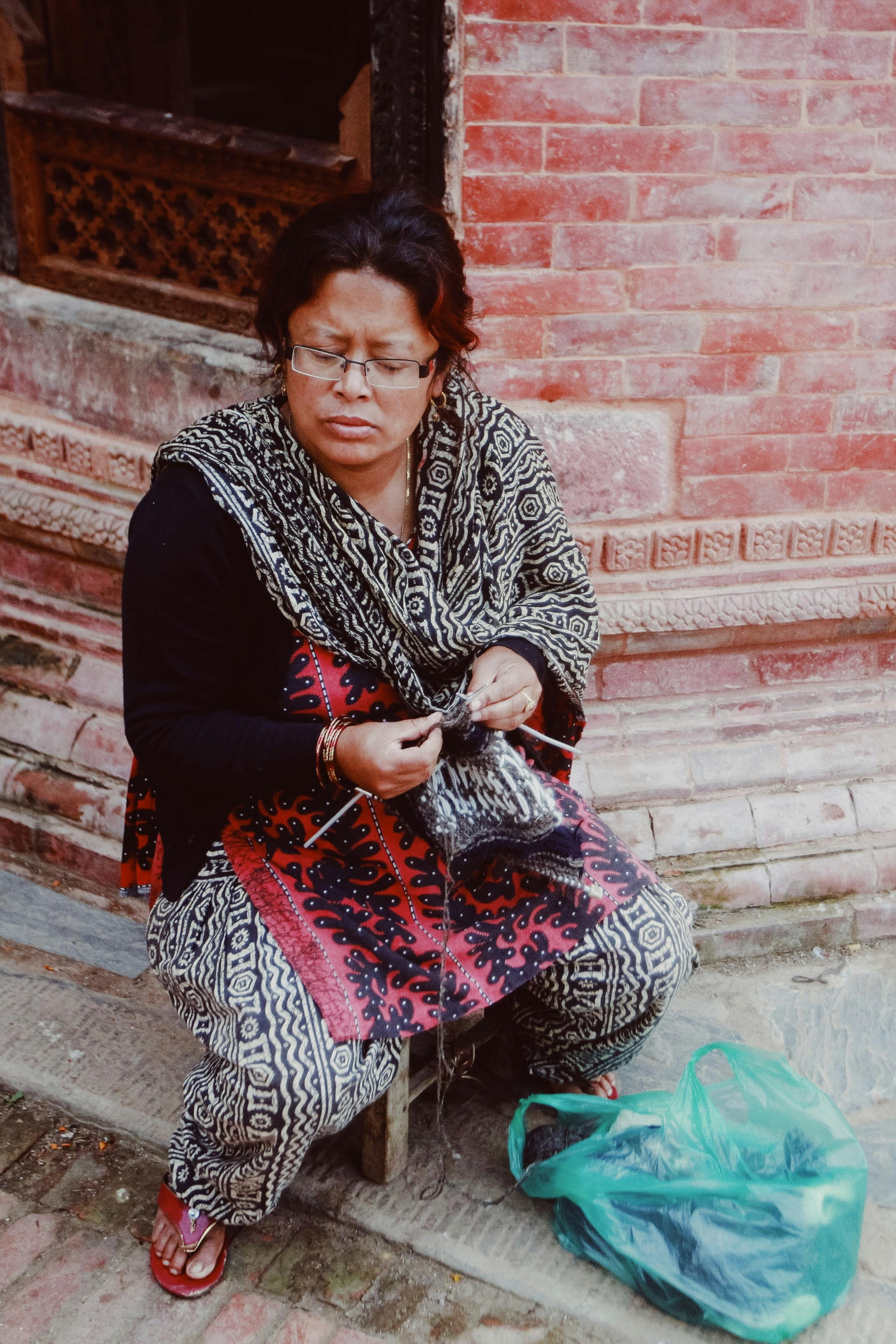 A Women Crocheting on a Street · Free Stock Photo