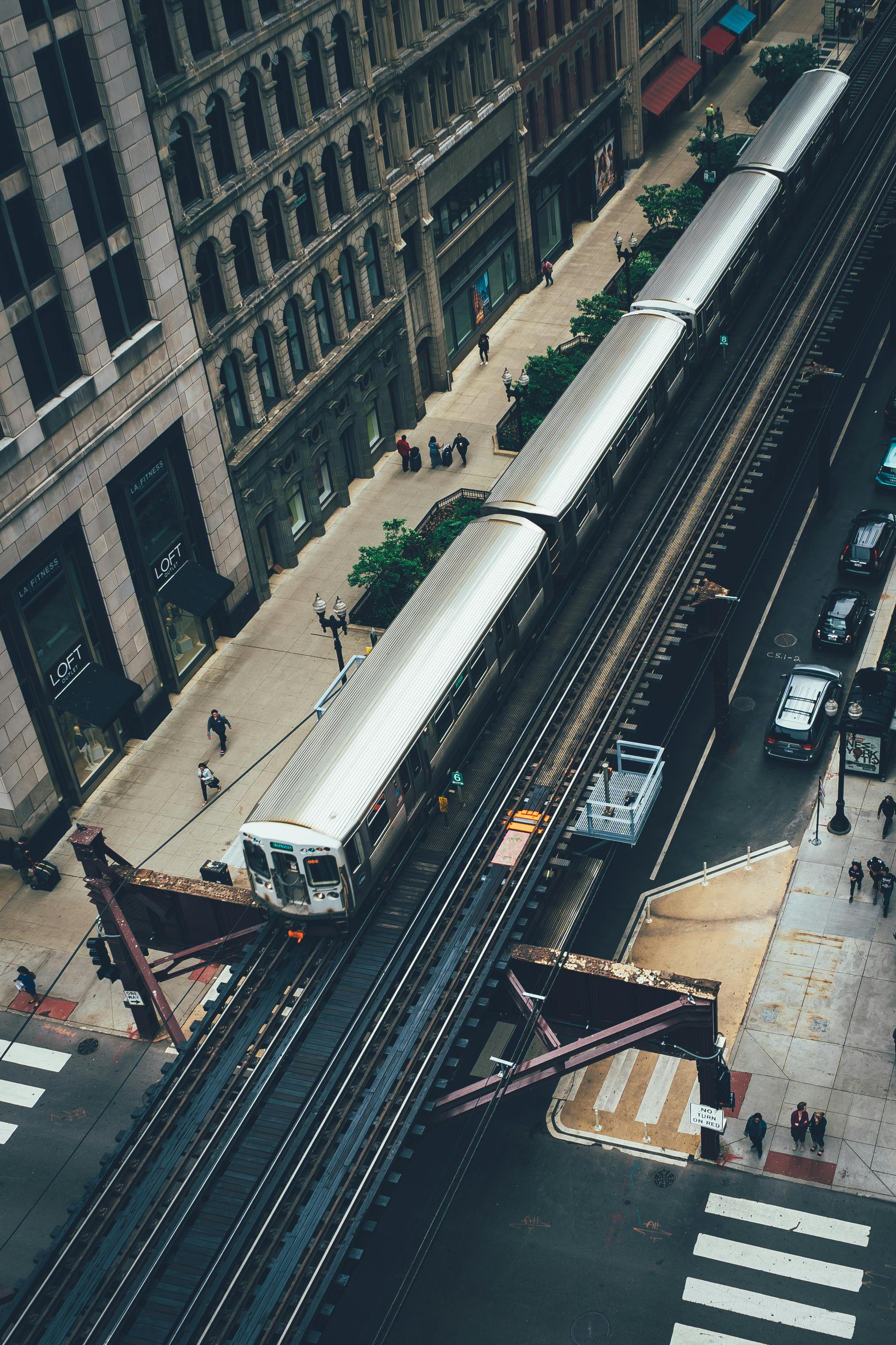 Aerial Photography of Gray Train Near Building · Free Stock Photo