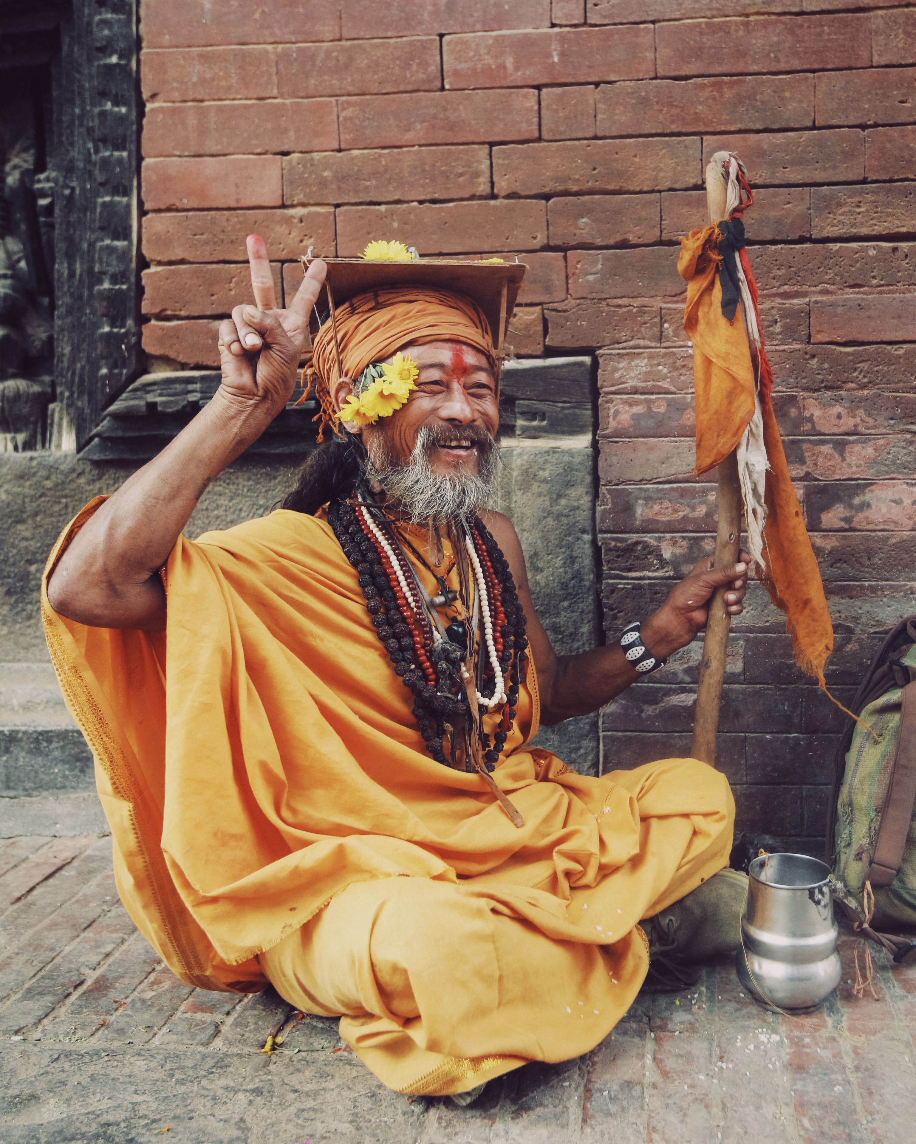 A Hindu Man in a Gown Sitting in front of a Temple · Free Stock Photo