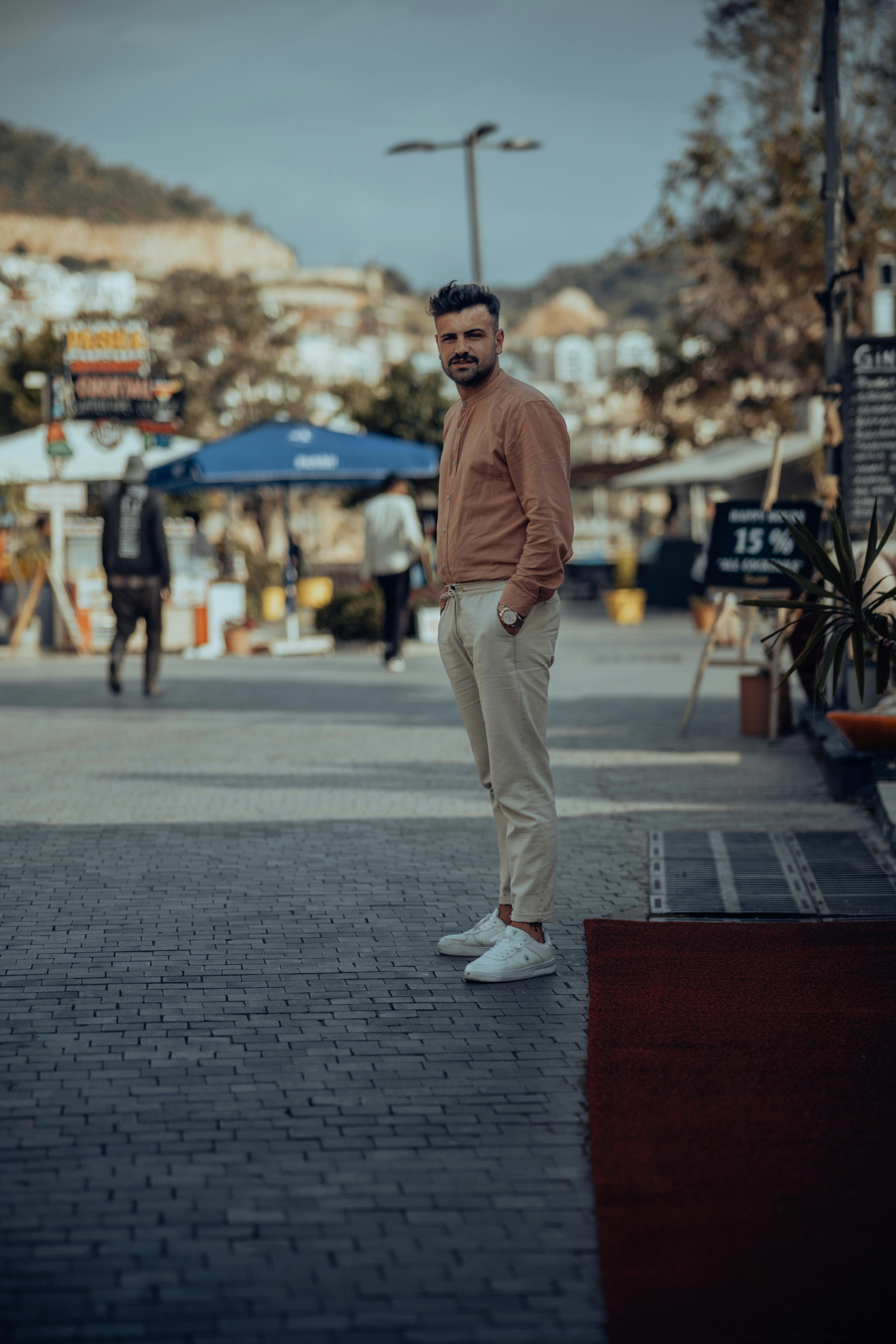 Autumnal Leaf Lying on the Pavement between the Legs of a Man · Free ...