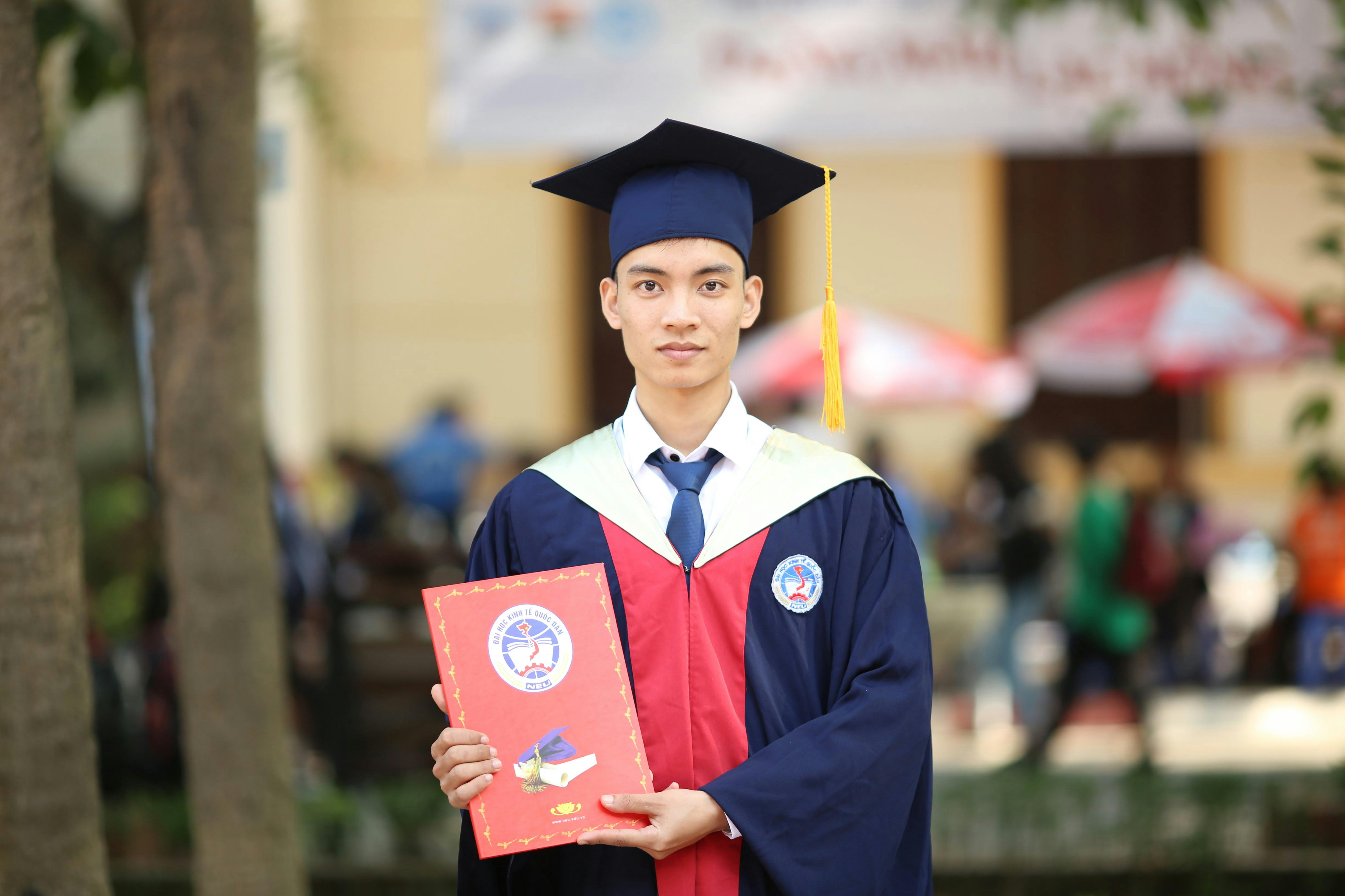 Man Wearing Academic Dress Near Building · Free Stock Photo