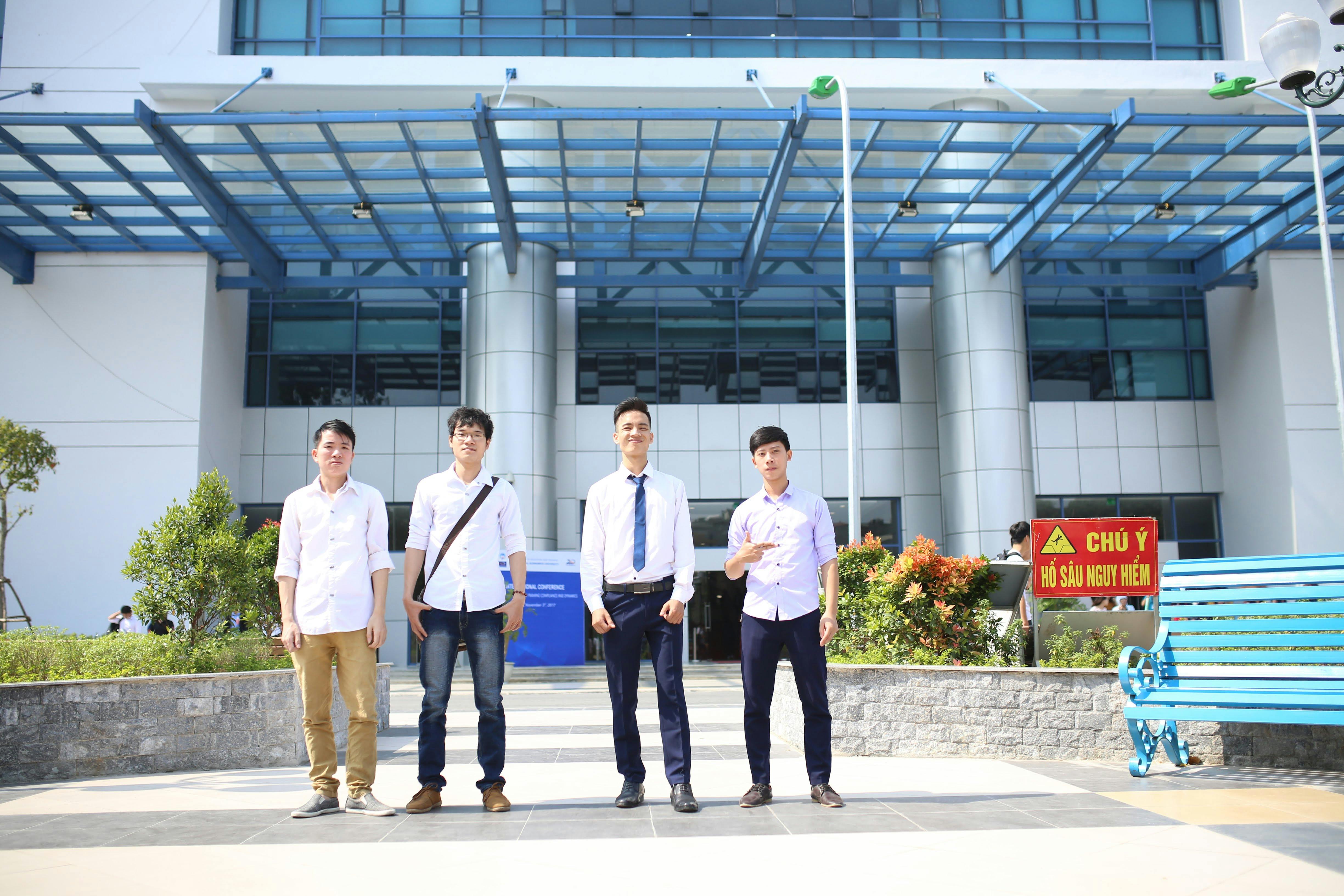 Four Men Standing Near the Building · Free Stock Photo