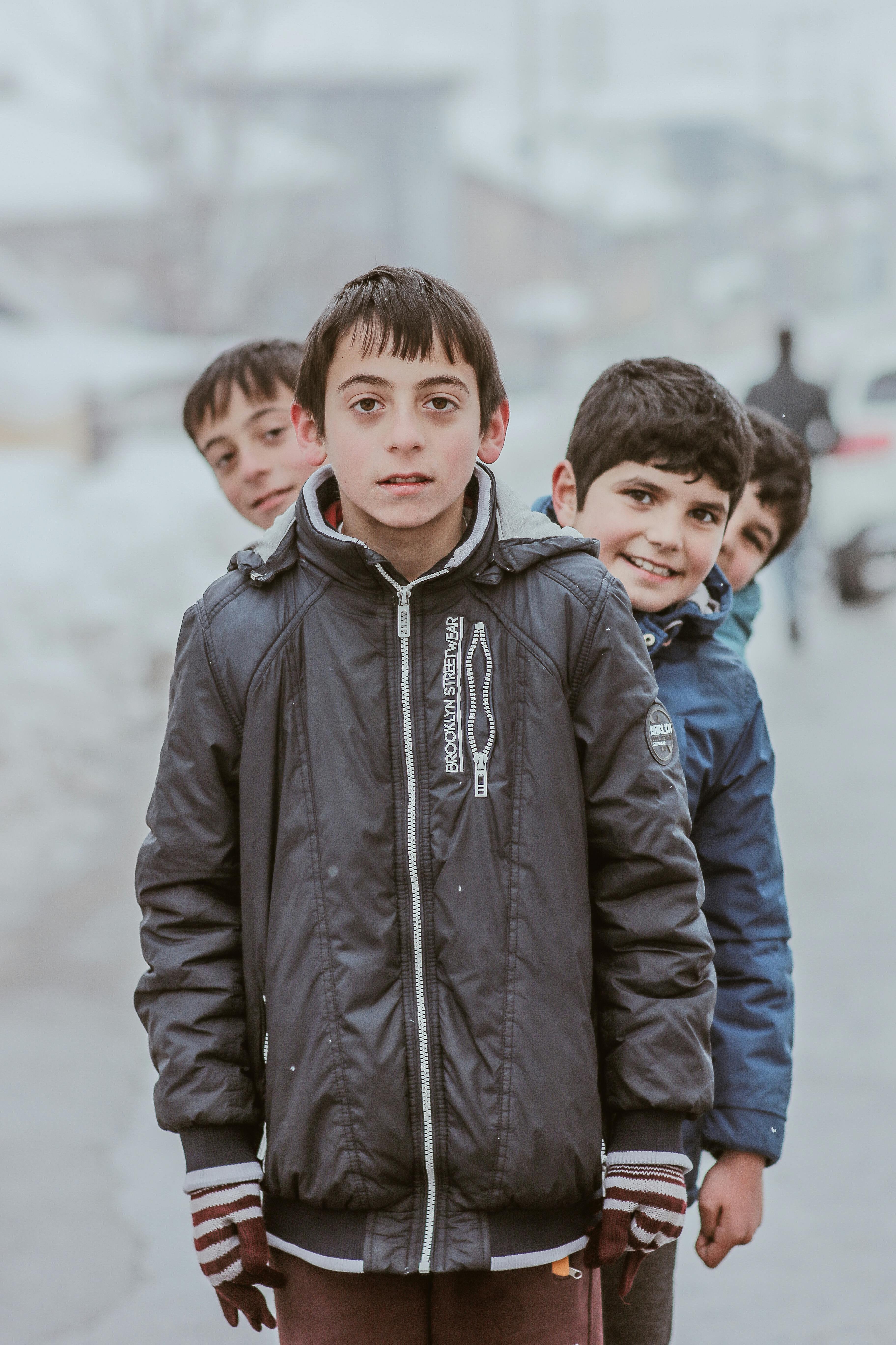 Photo of a Group of Boys Posing in a Row · Free Stock Photo