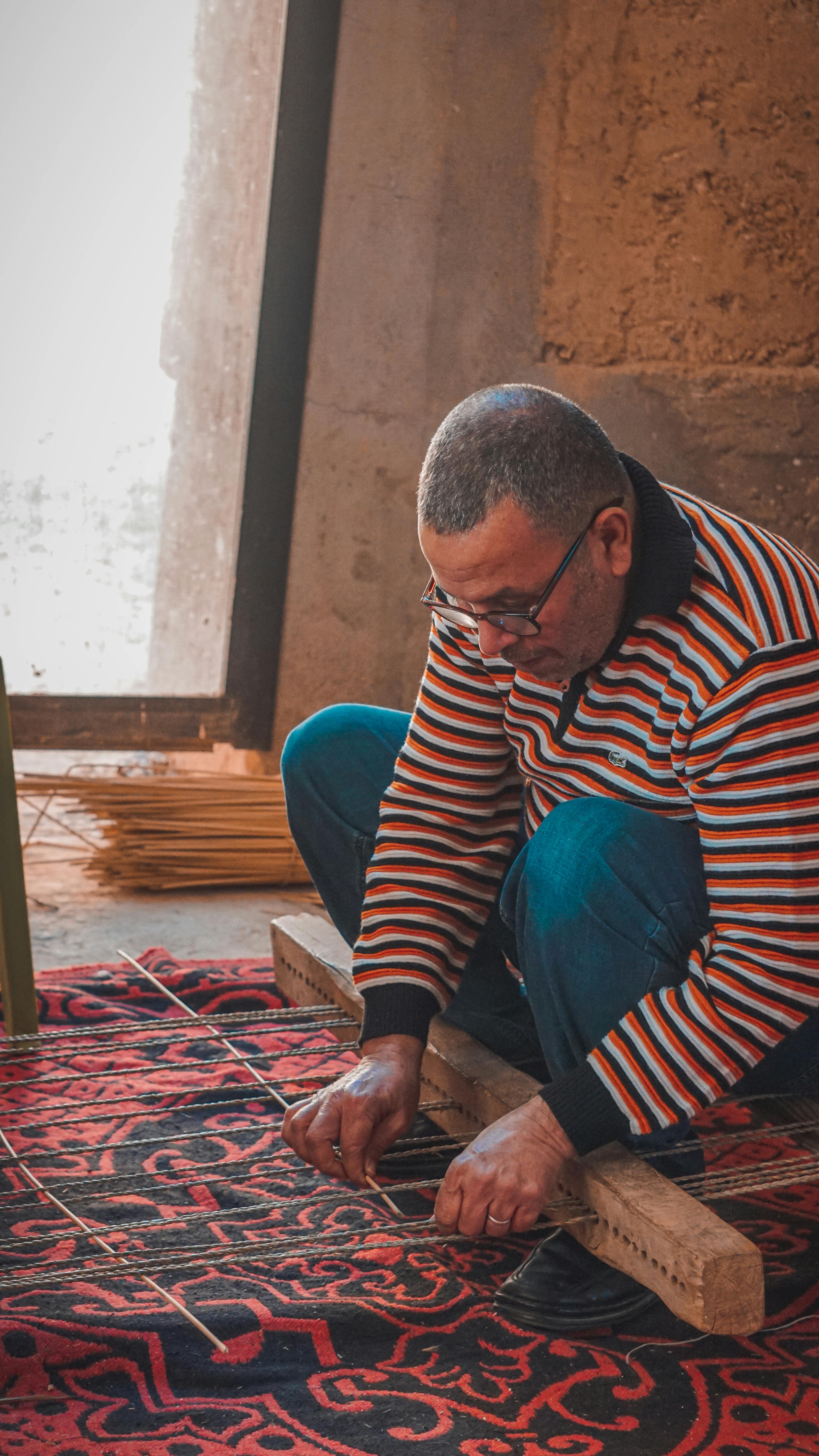 Man Weaving a Carpet · Free Stock Photo