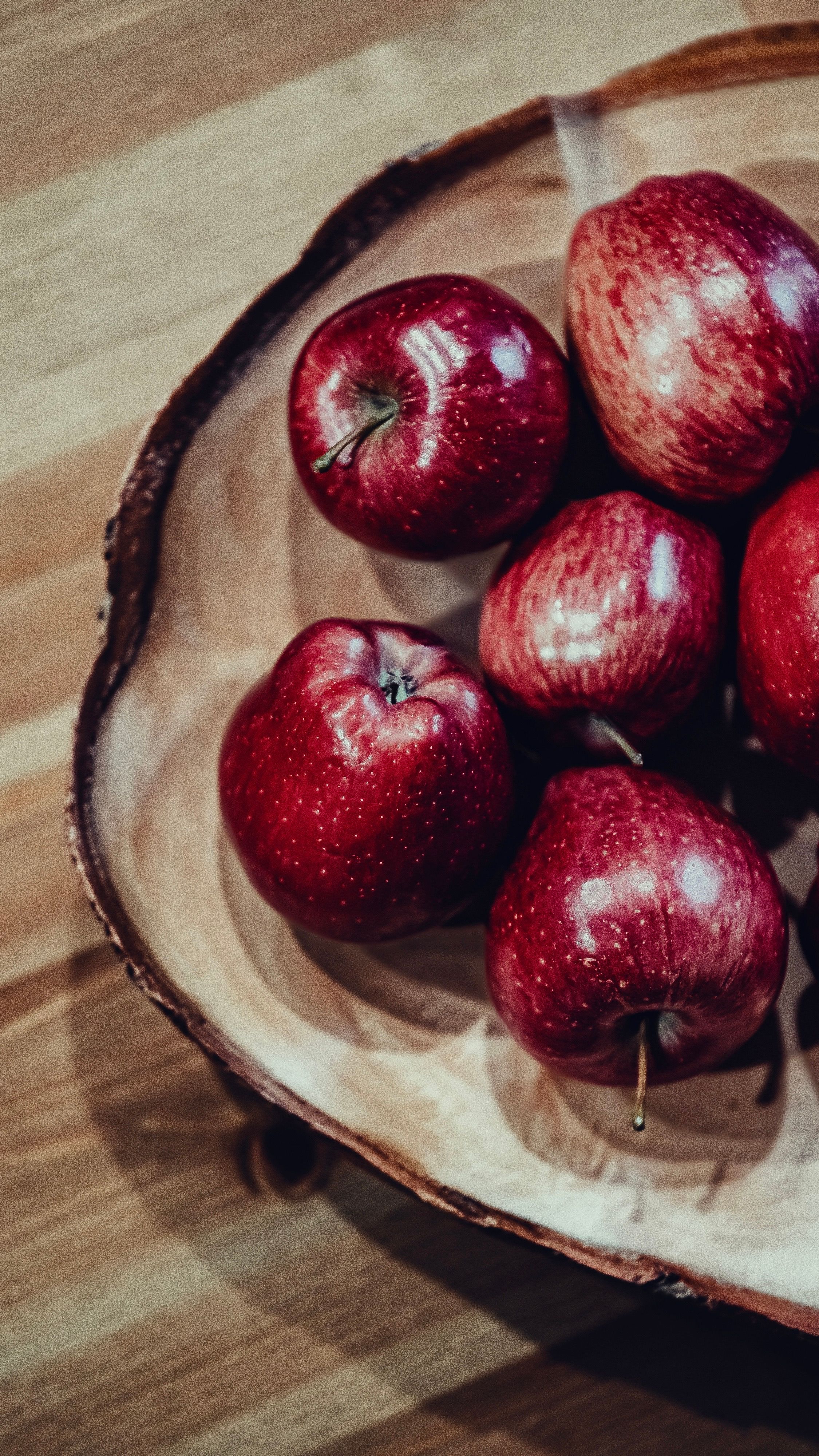 A bowl of red apples on a wooden table · Free Stock Photo