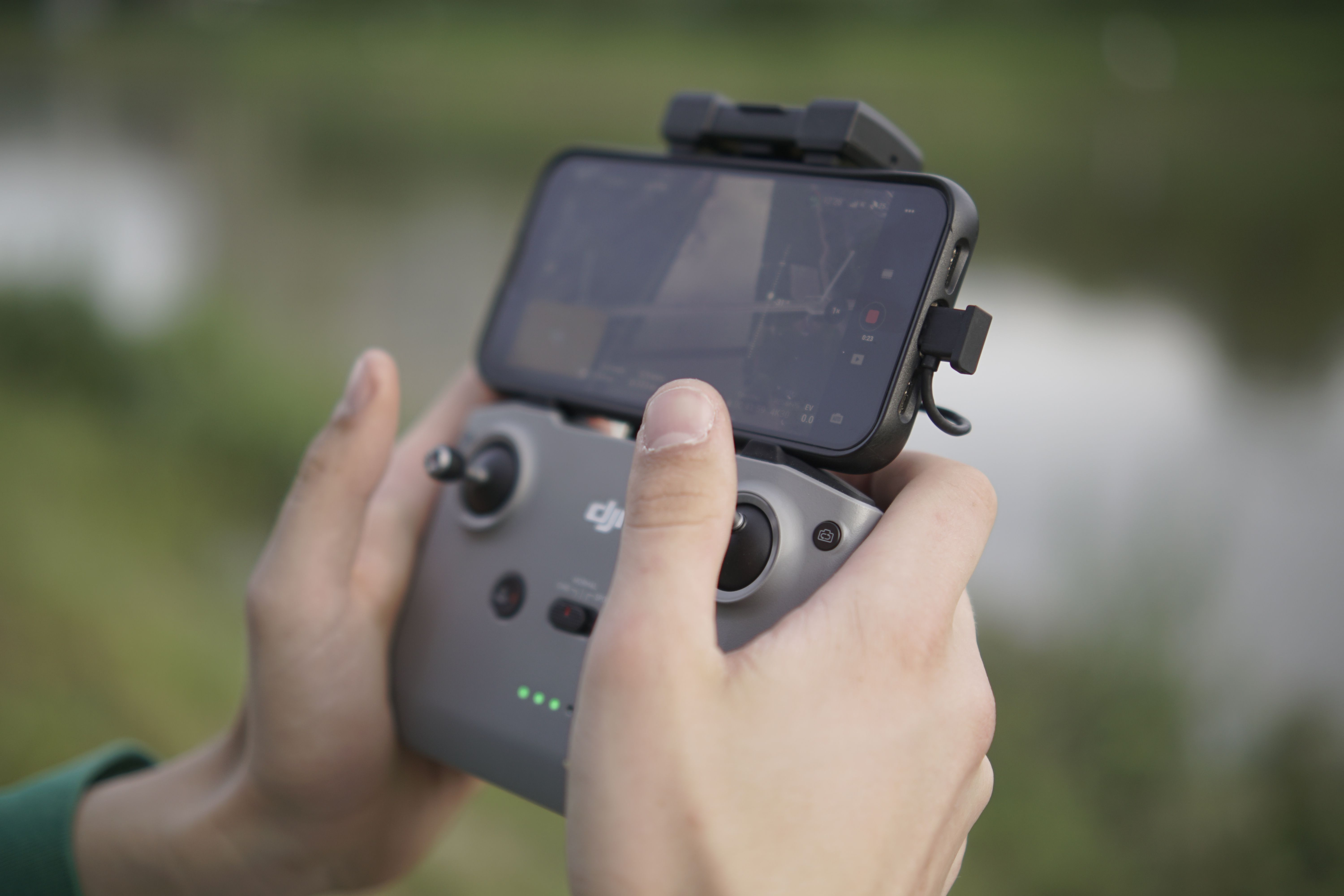 Close-up of a Man Holding a Drone Controller with Attached Smartphone ...