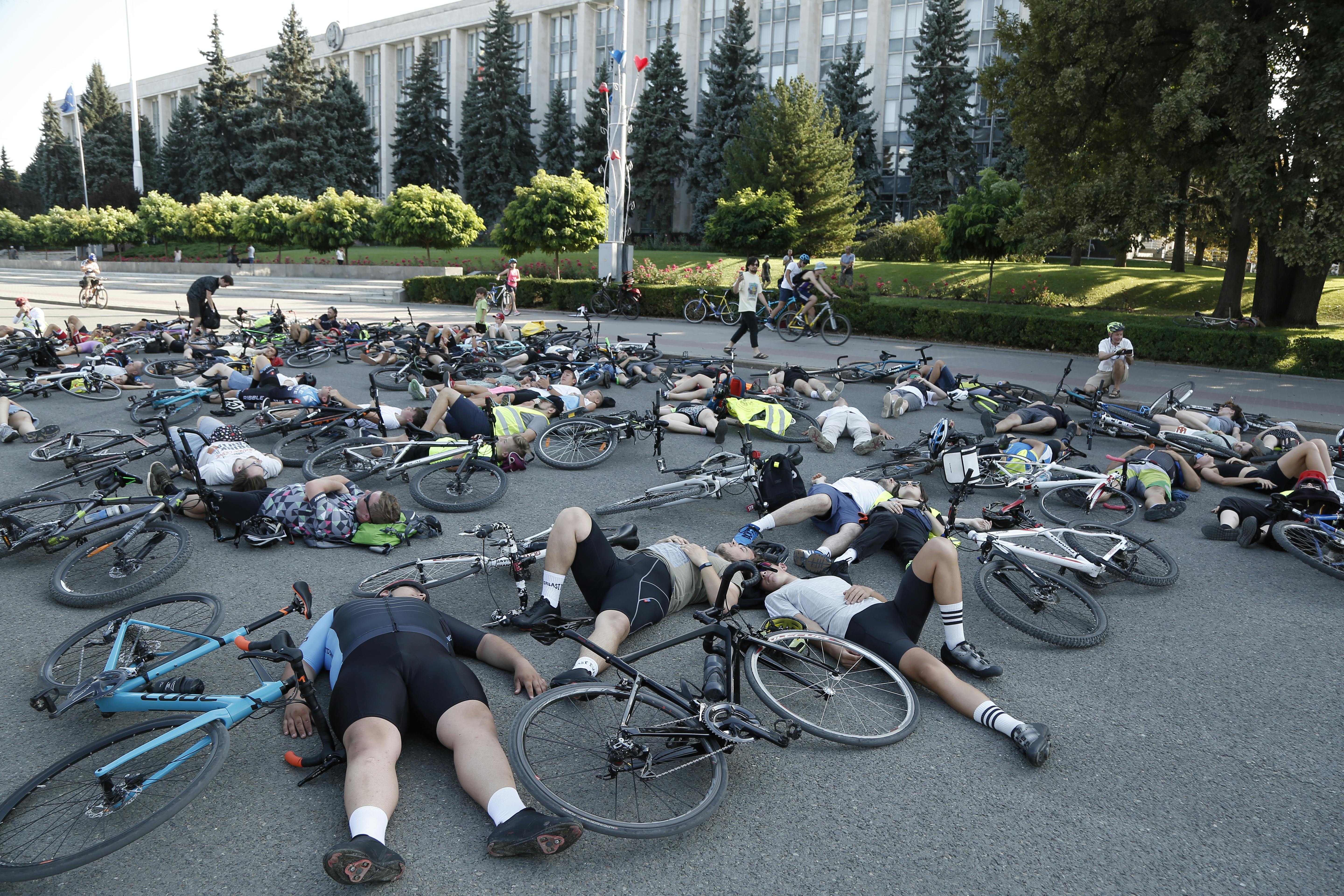 Cyclists Lying on Ground in City · Free Stock Photo