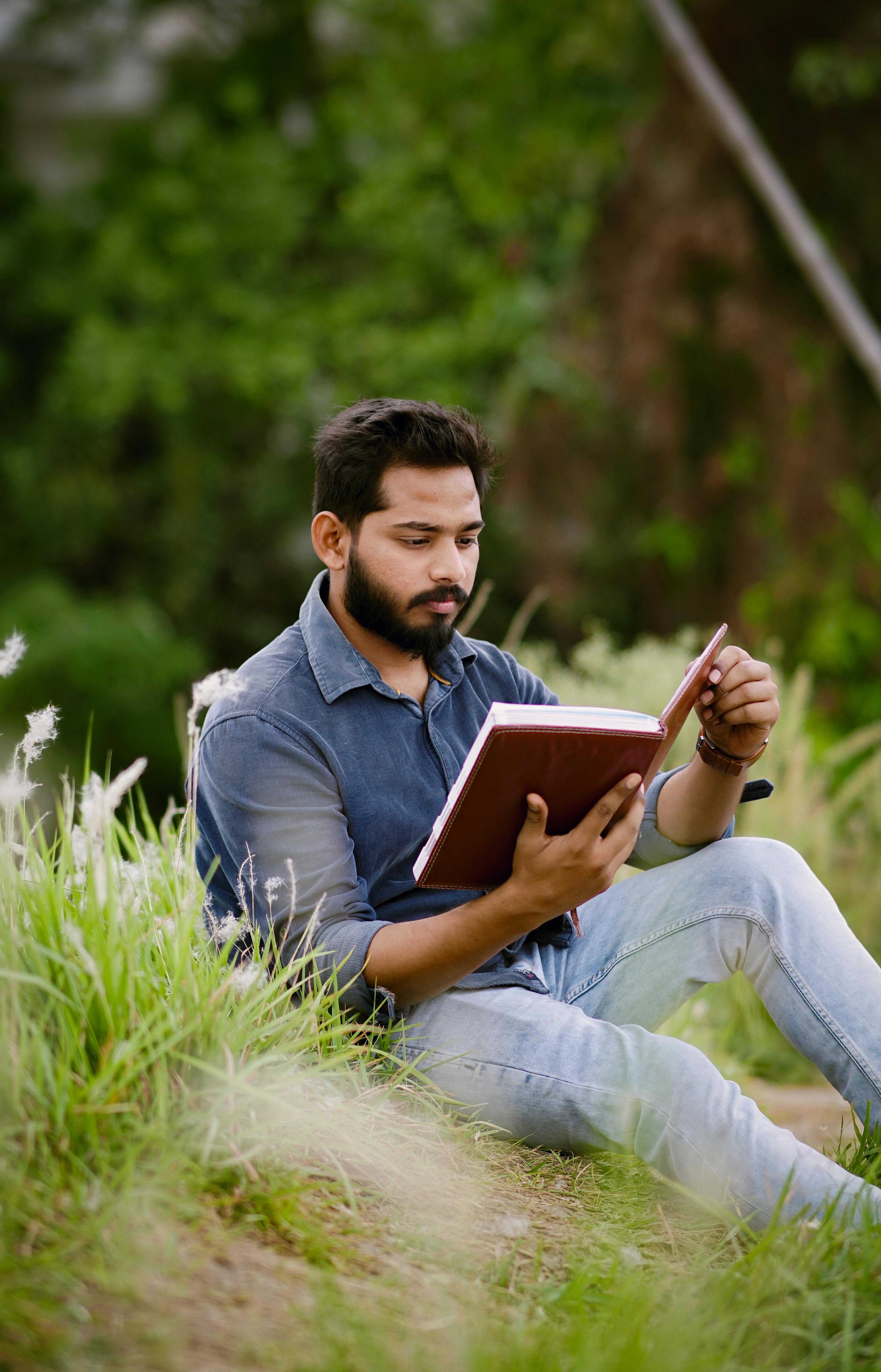 Man Reading Book in Outdoors at Night · Free Stock Photo