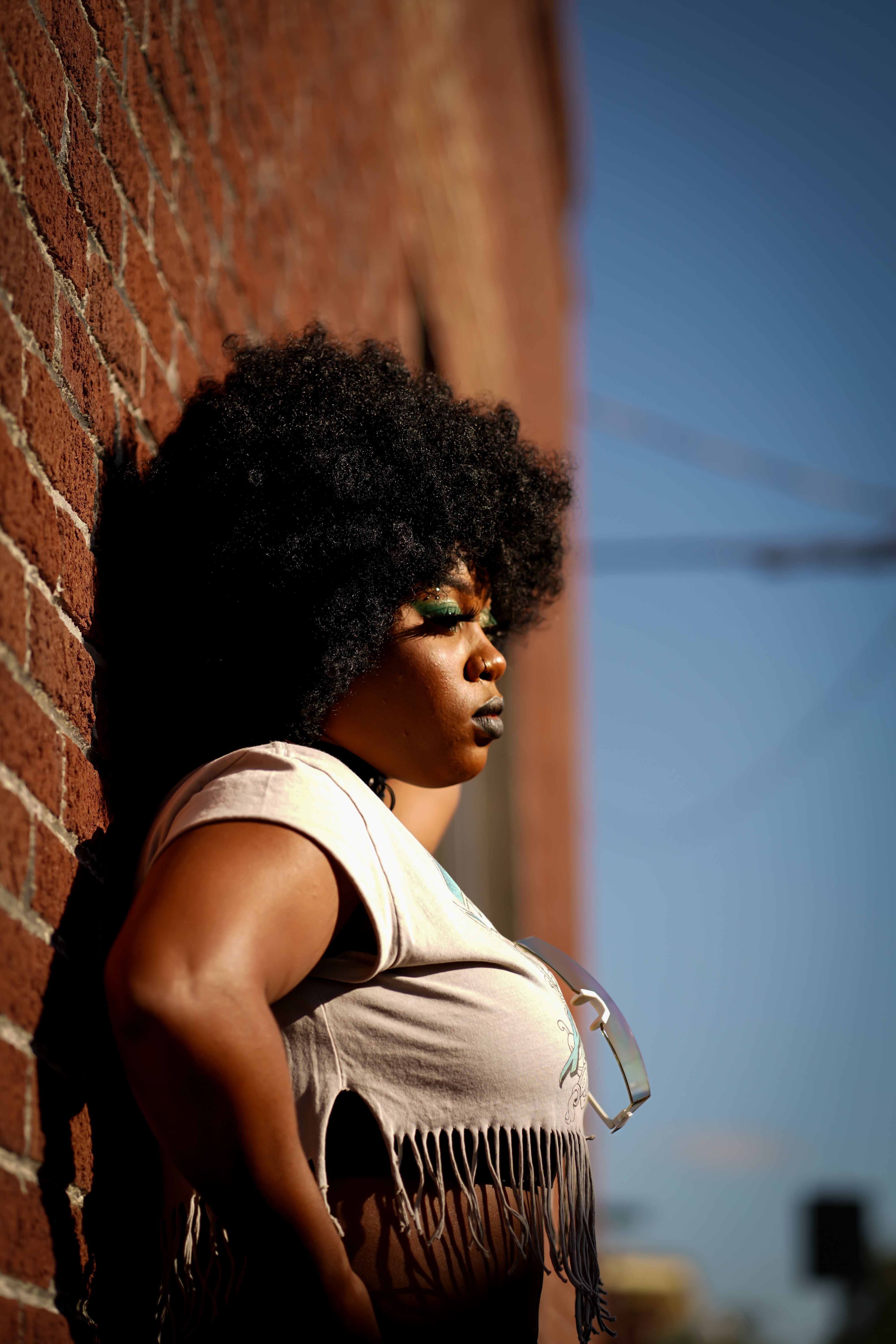 Young Woman Standing with Her Back against the Wall · Free Stock Photo