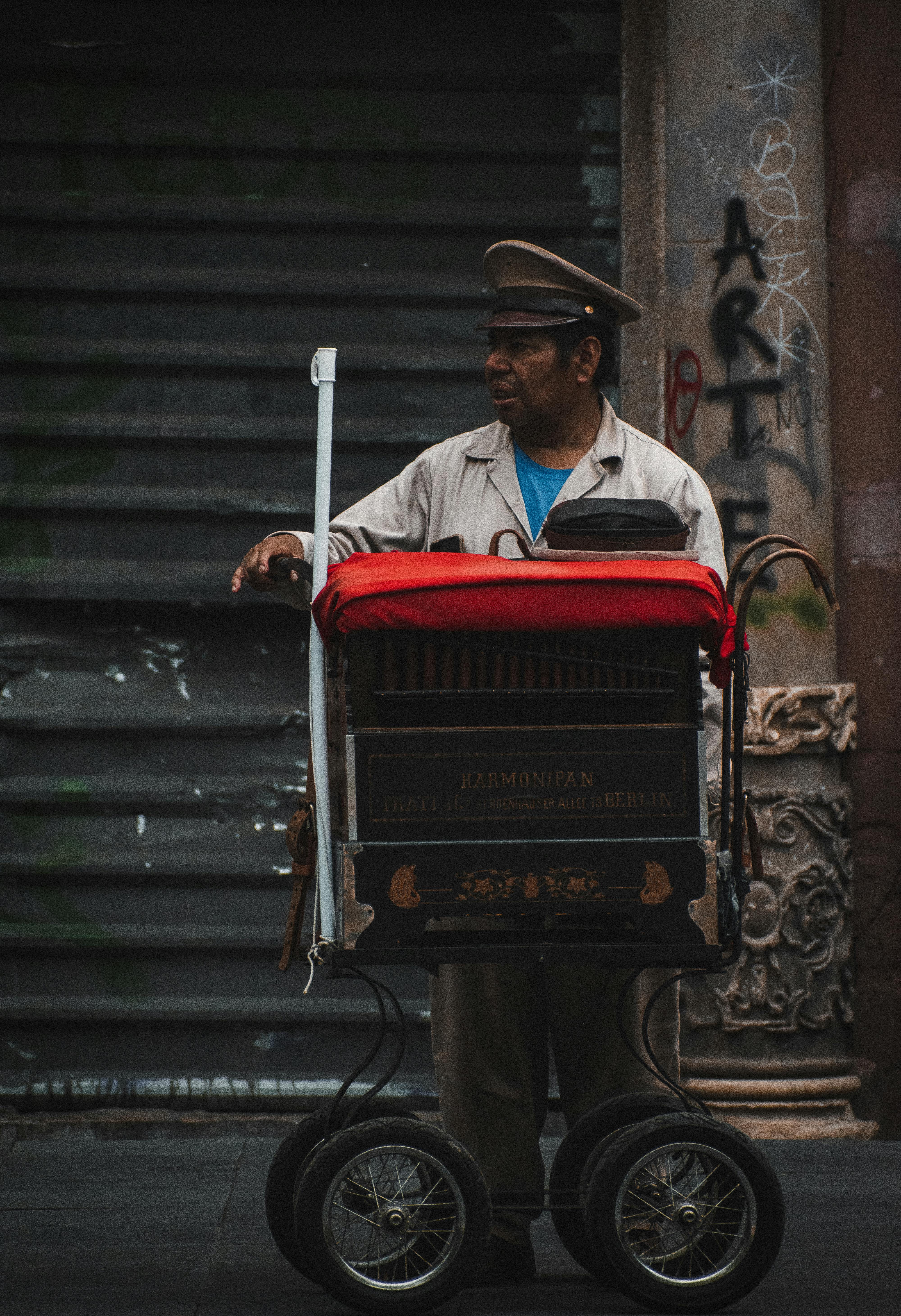 Man with Music Box on Sidewalk · Free Stock Photo