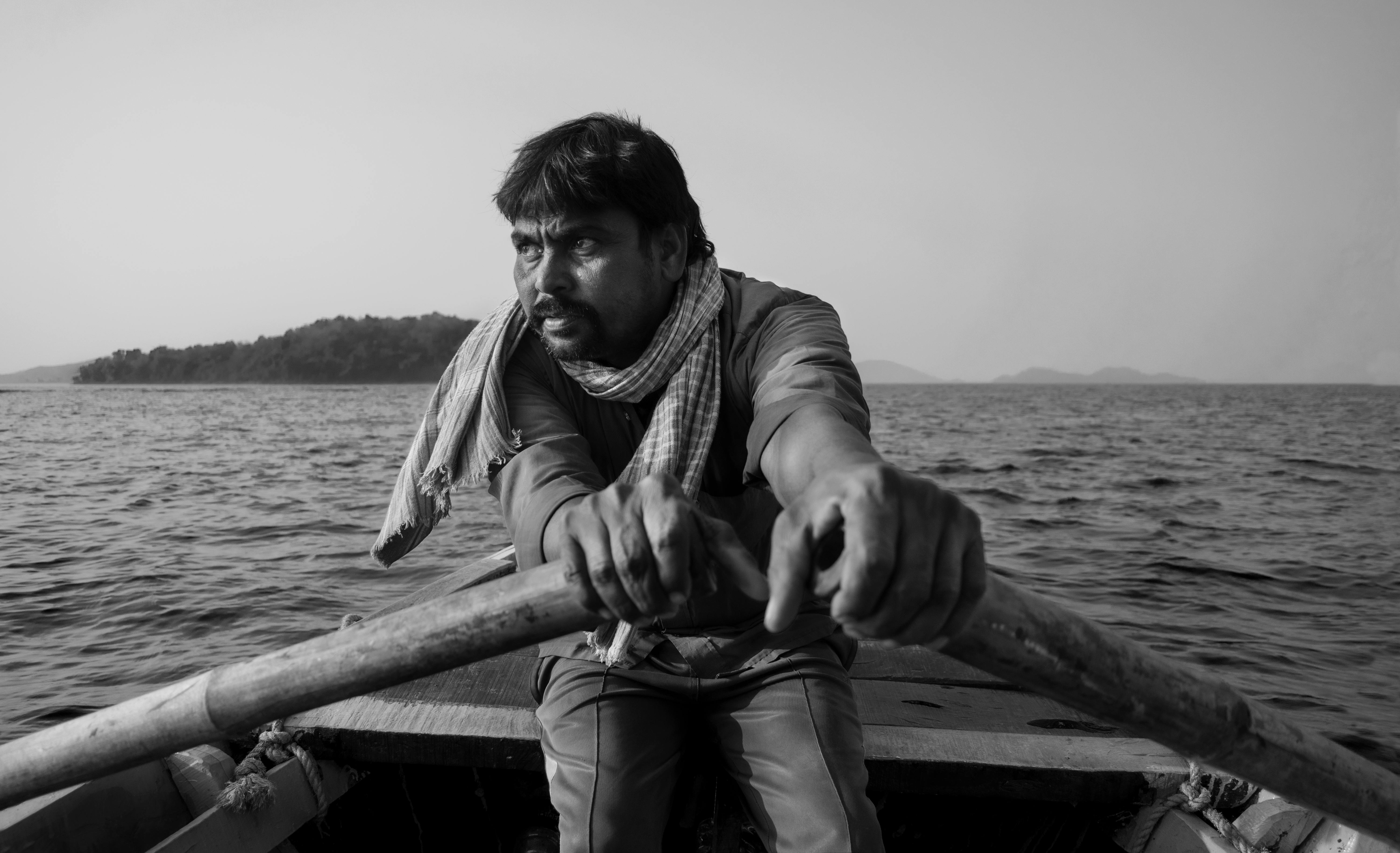 Men Rowing a Wooden Boat · Free Stock Photo