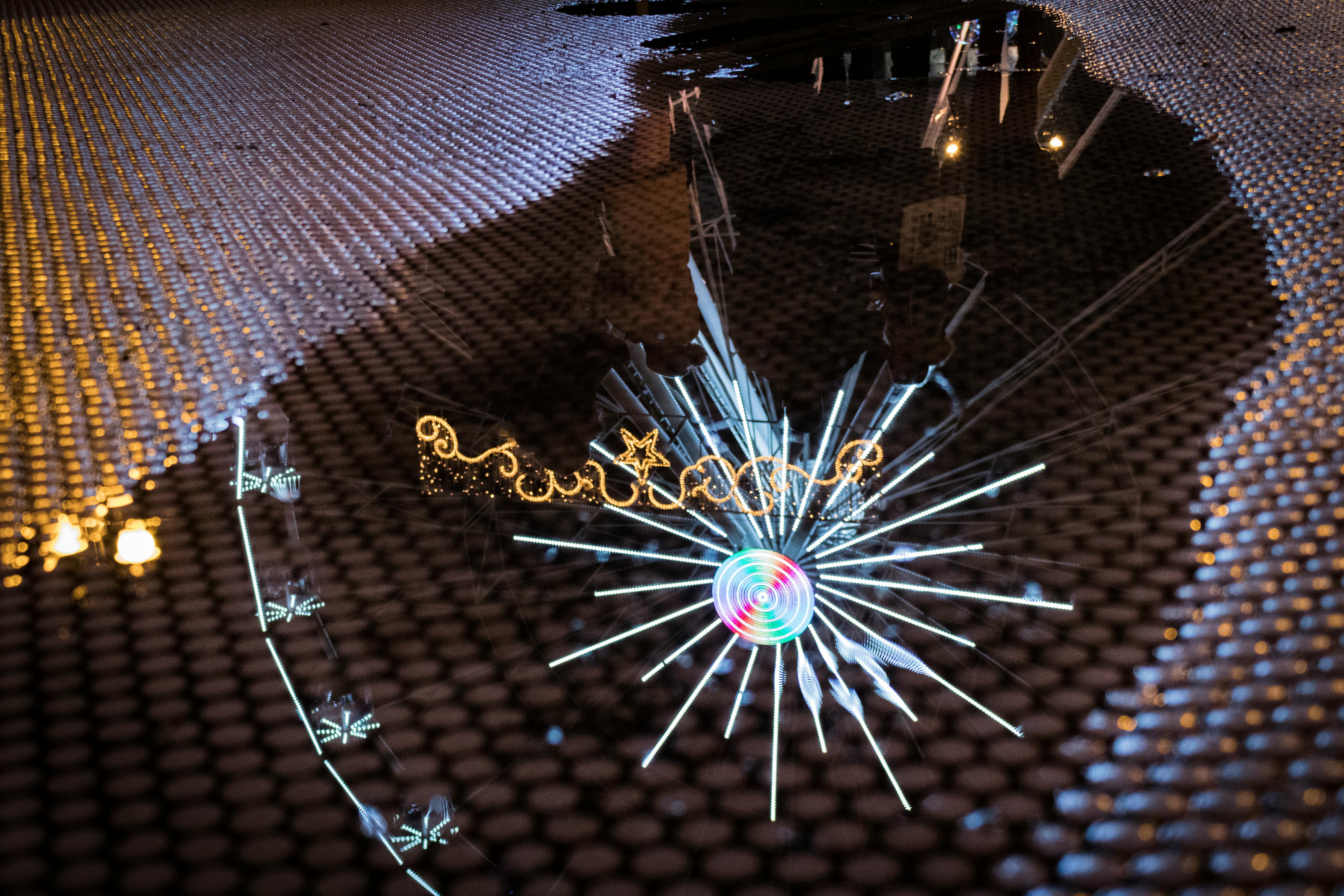 Reflection of Christmas Lights in Puddle · Free Stock Photo