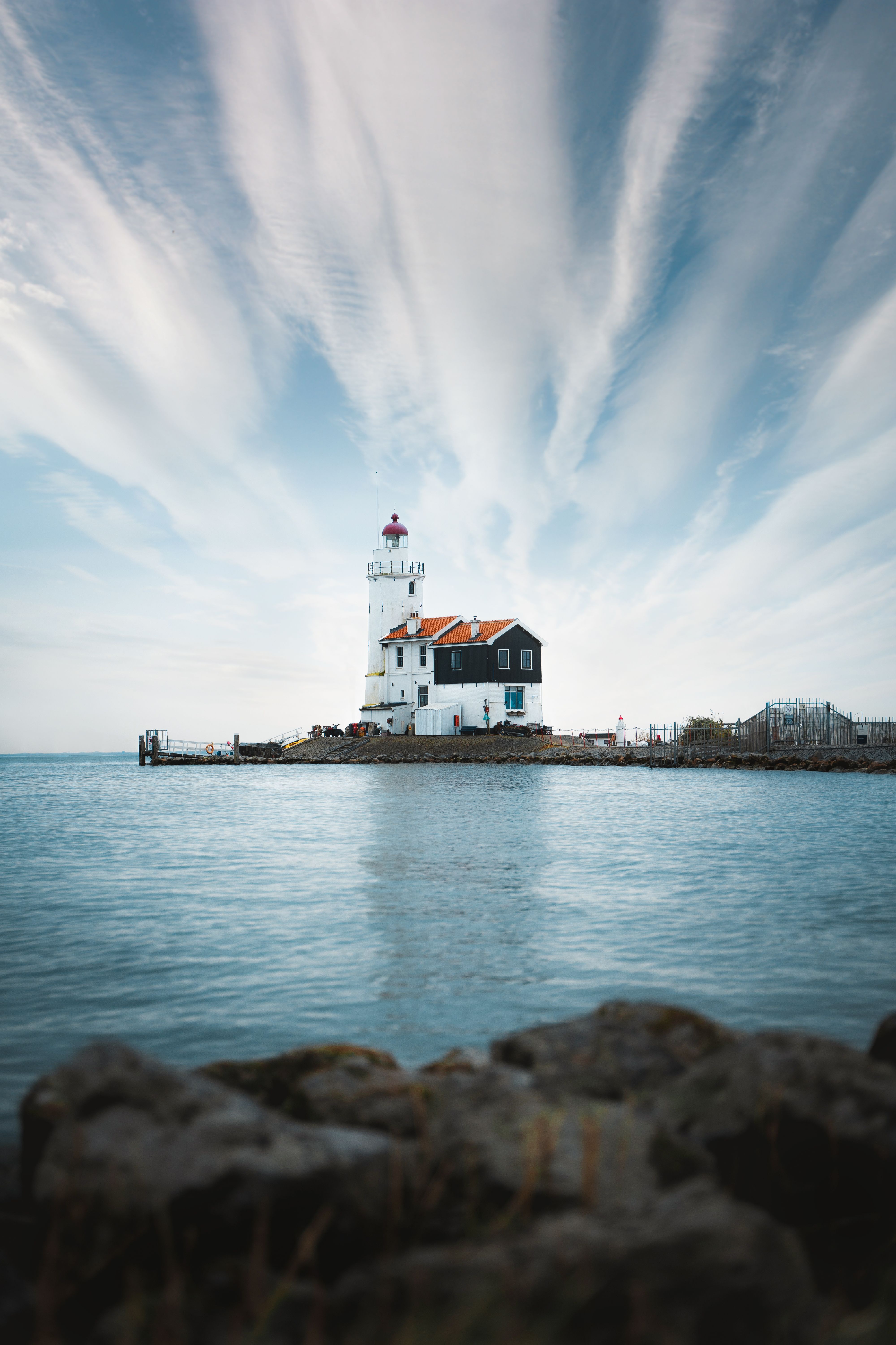 Photo of a Lighthouse Under a Cloudy Sky · Free Stock Photo