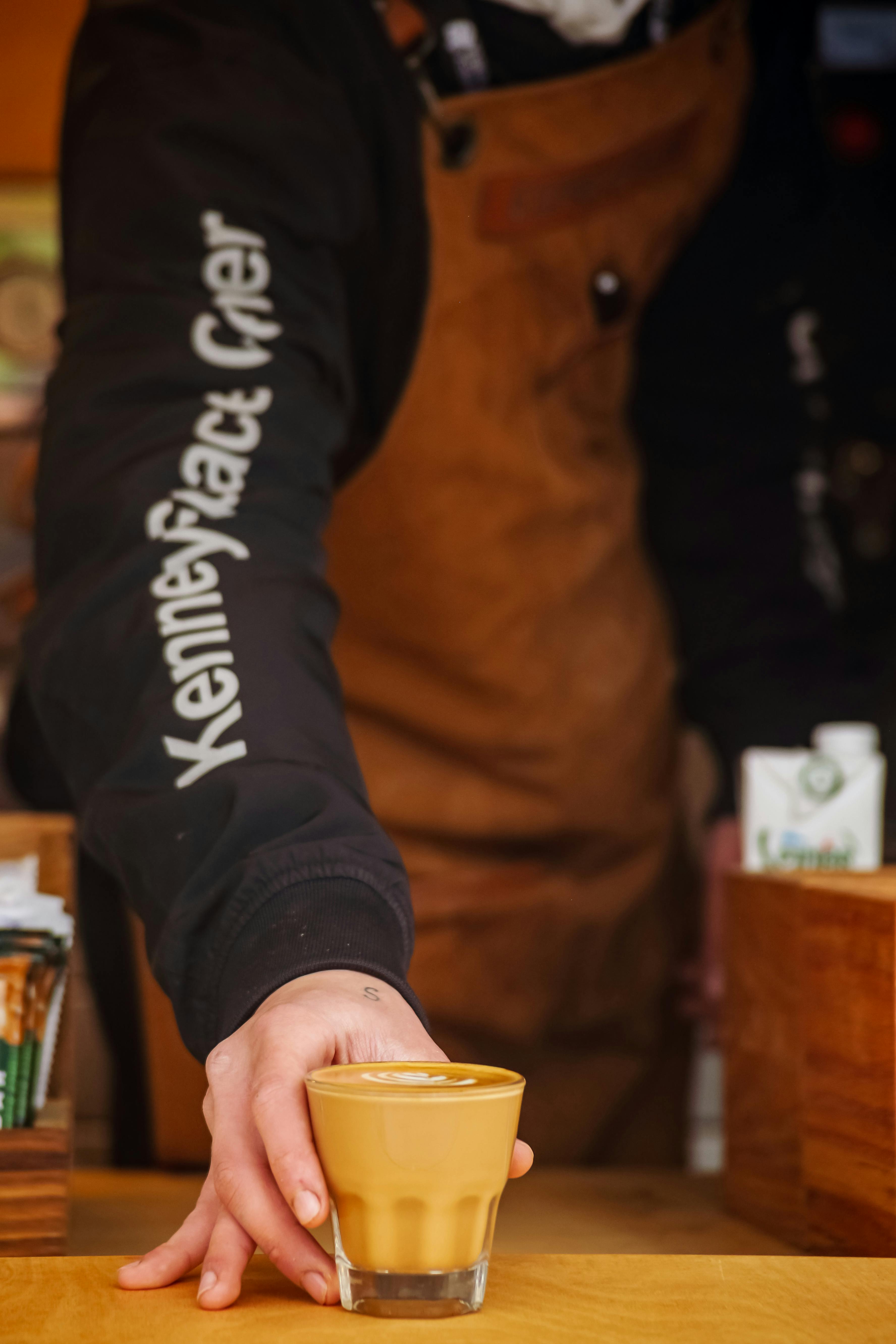 Man Serving Coffee in a Glass in a Restaurant · Free Stock Photo