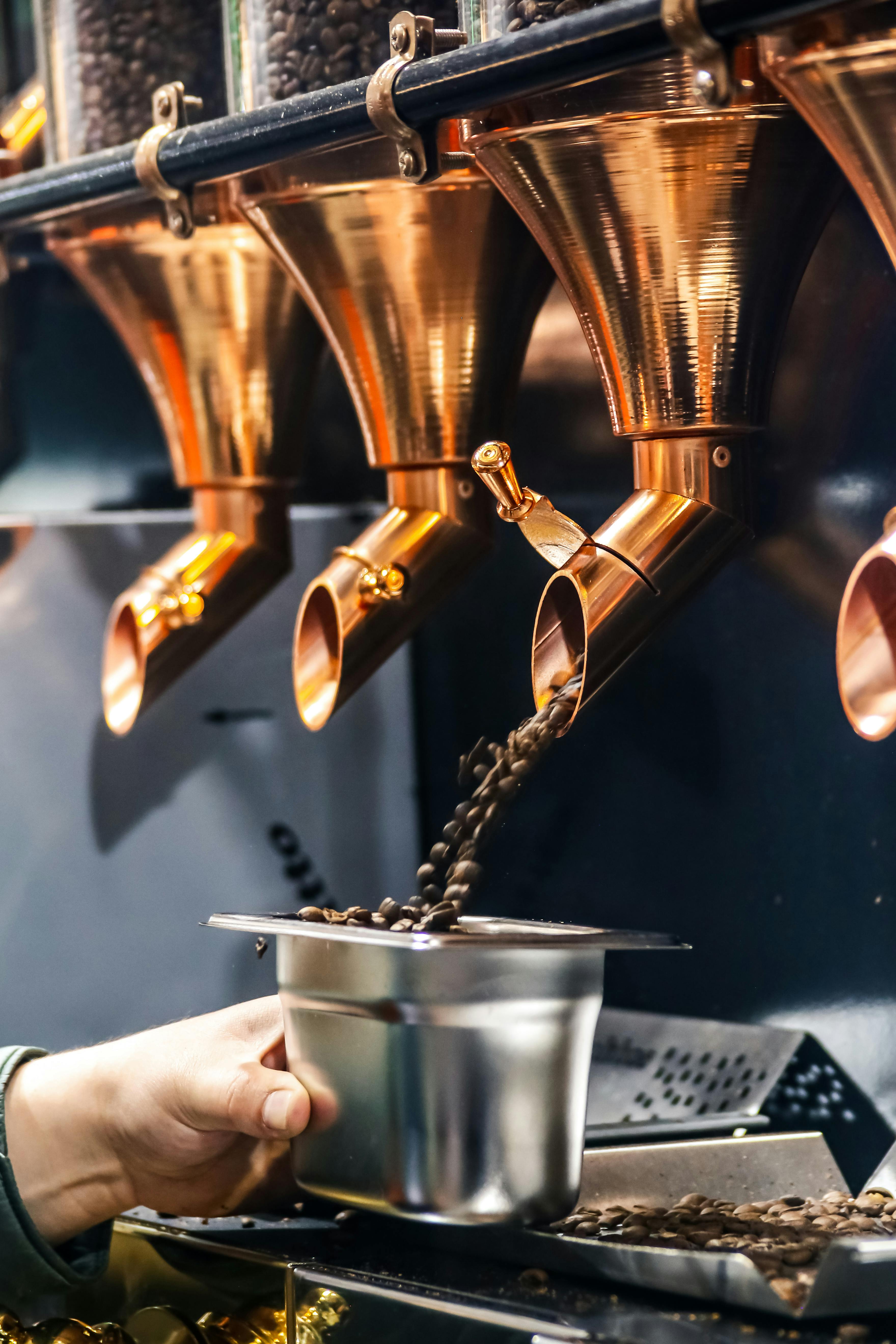 Man Getting Coffee Beans into a Coffee Machine · Free Stock Photo